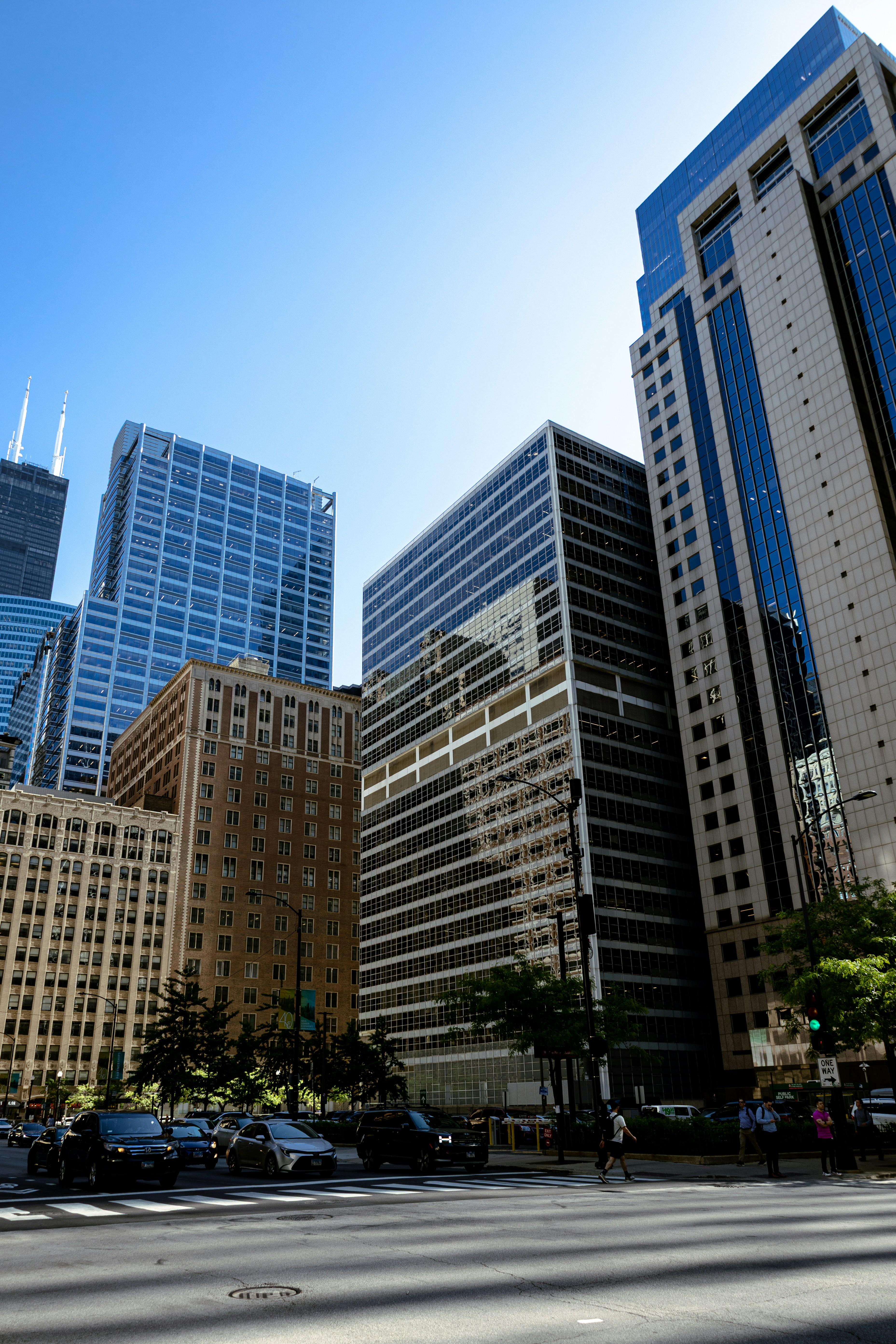 Towering Geometry: Cityscape Under a Clear Blue Sky
