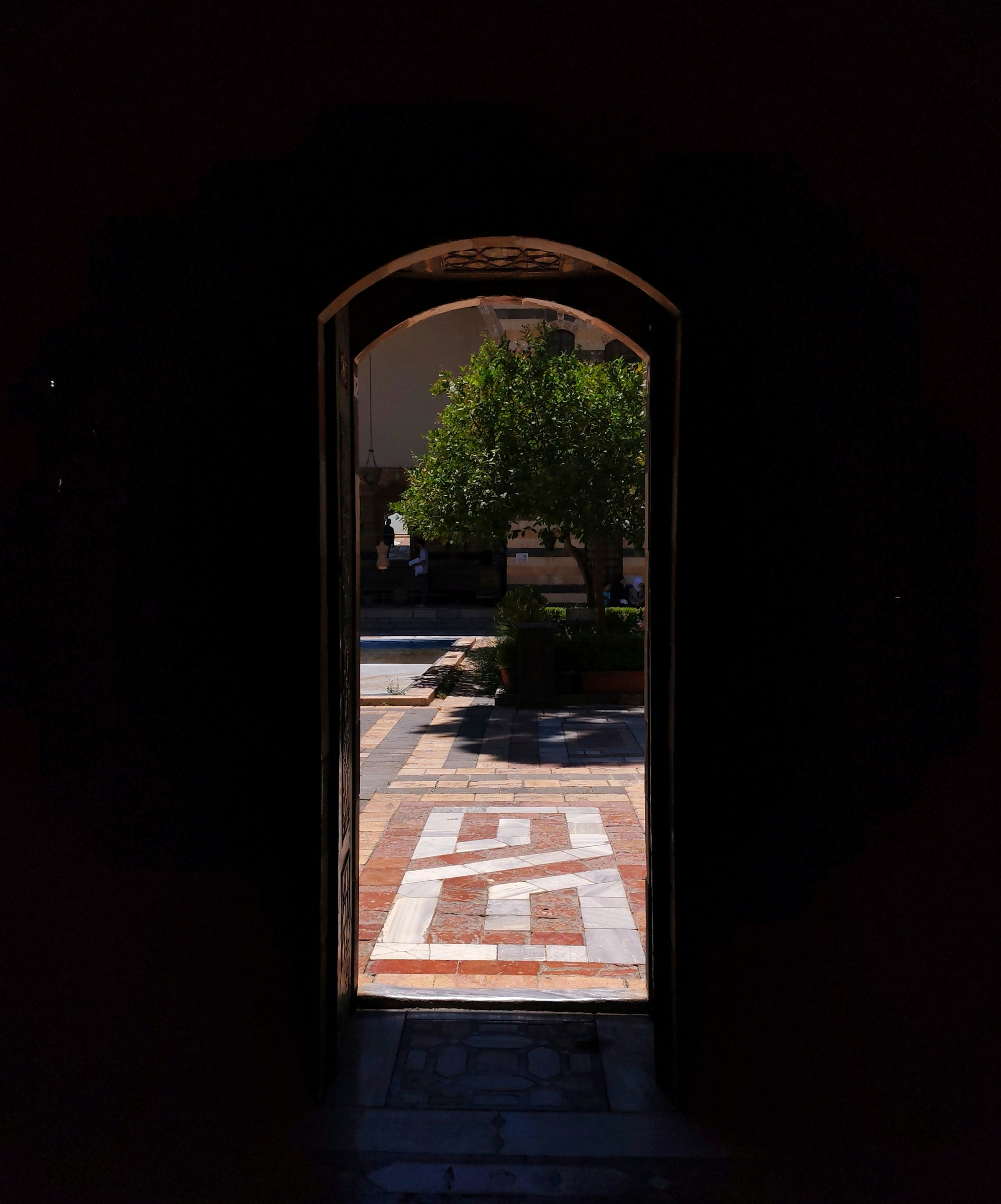 Light at the Archway: Garden View Through a Threshold