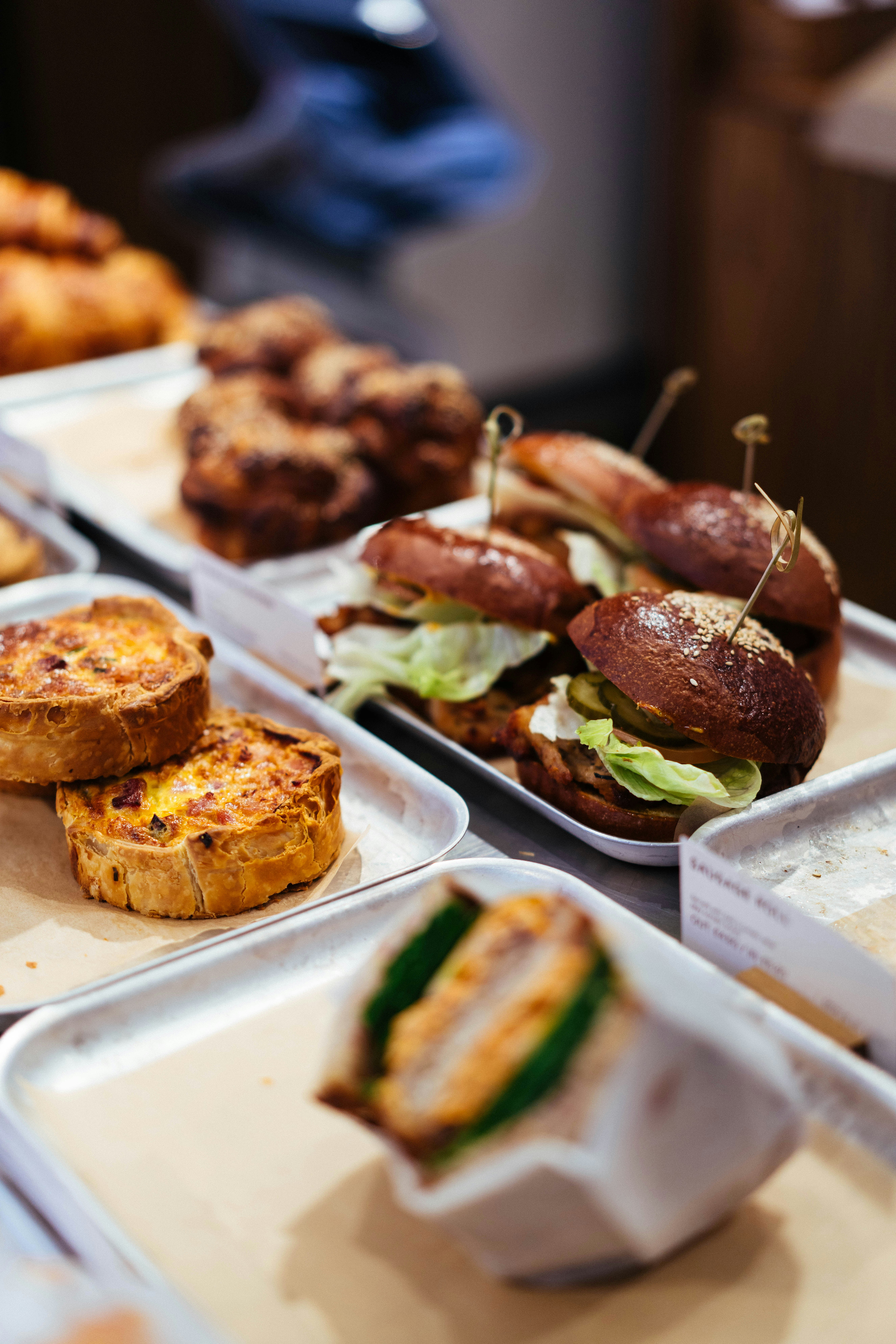 Burger bite and pastry parade on a catering counter