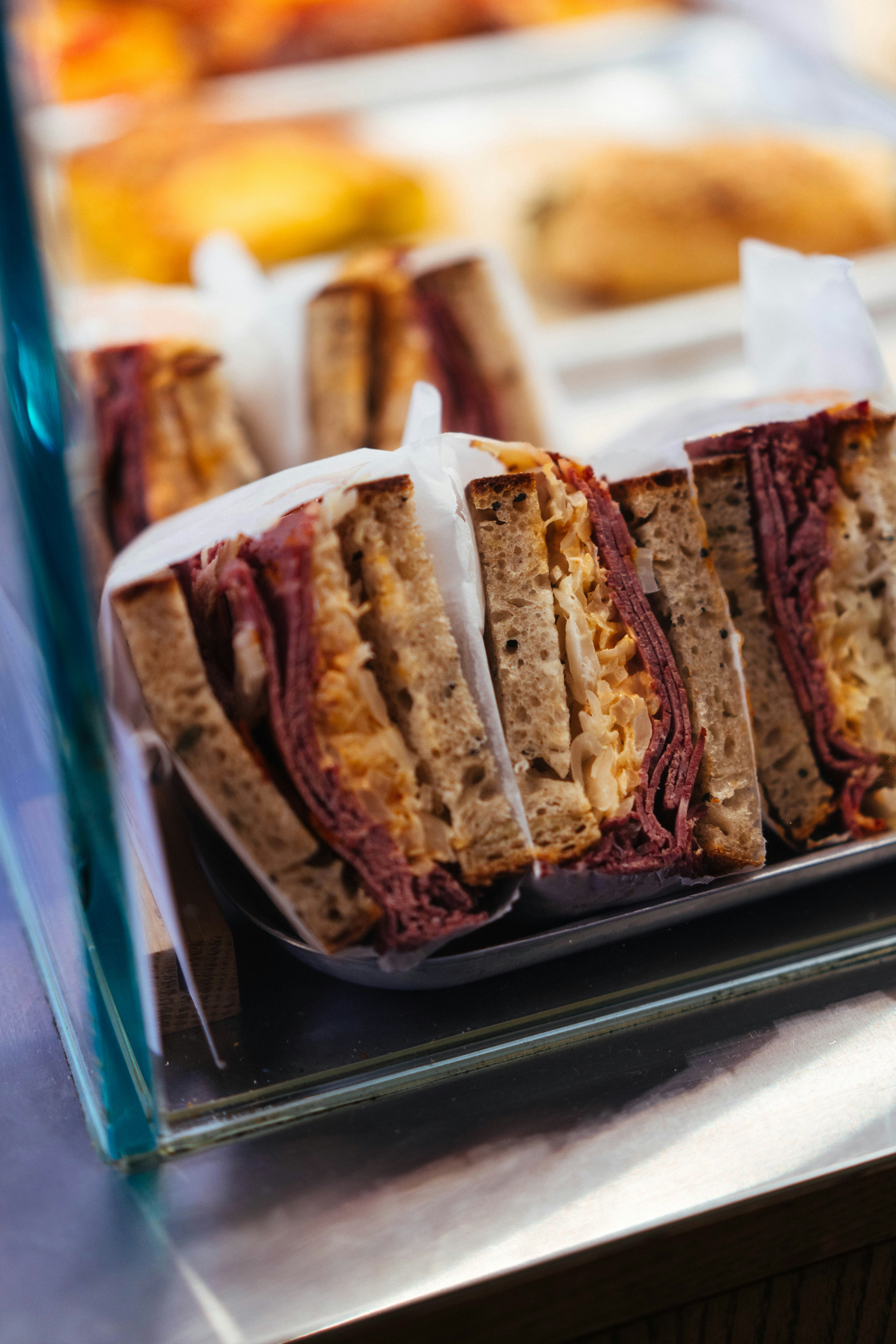 Sliced Pastry Rows: A Close-Up of Layers and Texture in a Glass Display