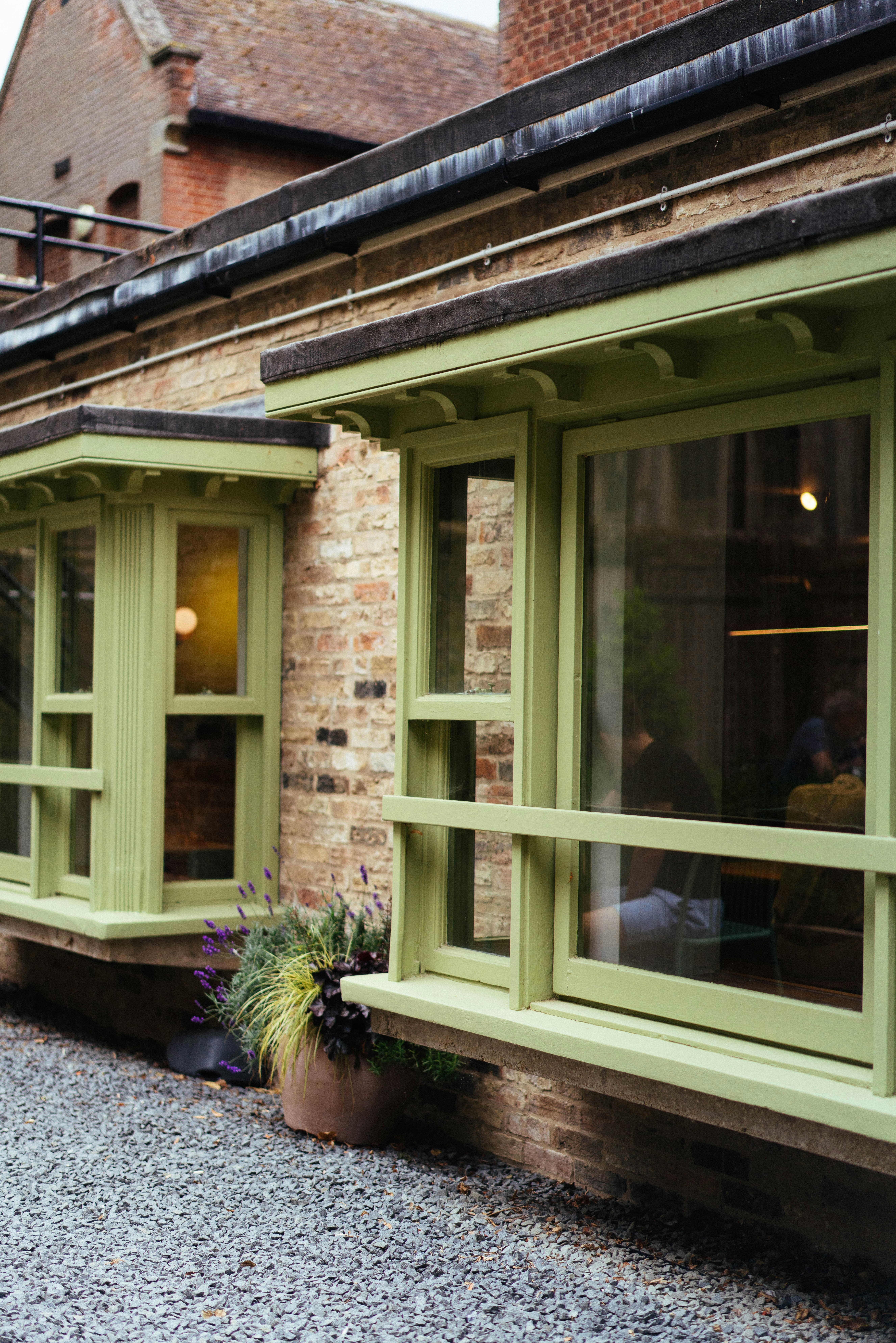 Green-framed Windows on Brick Edifice