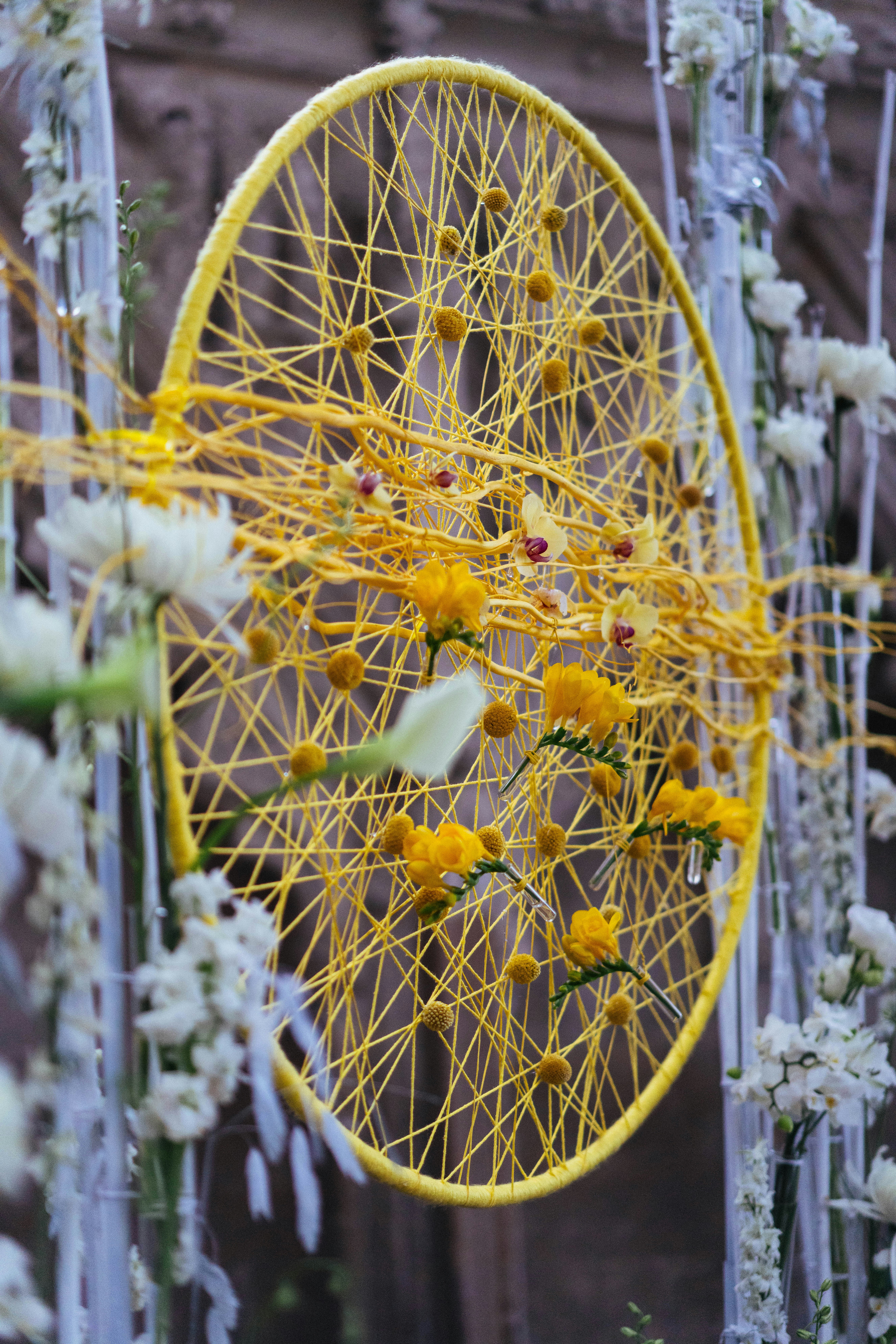 Yellow Dream_RING: a suspended wheel of yarn and flowers