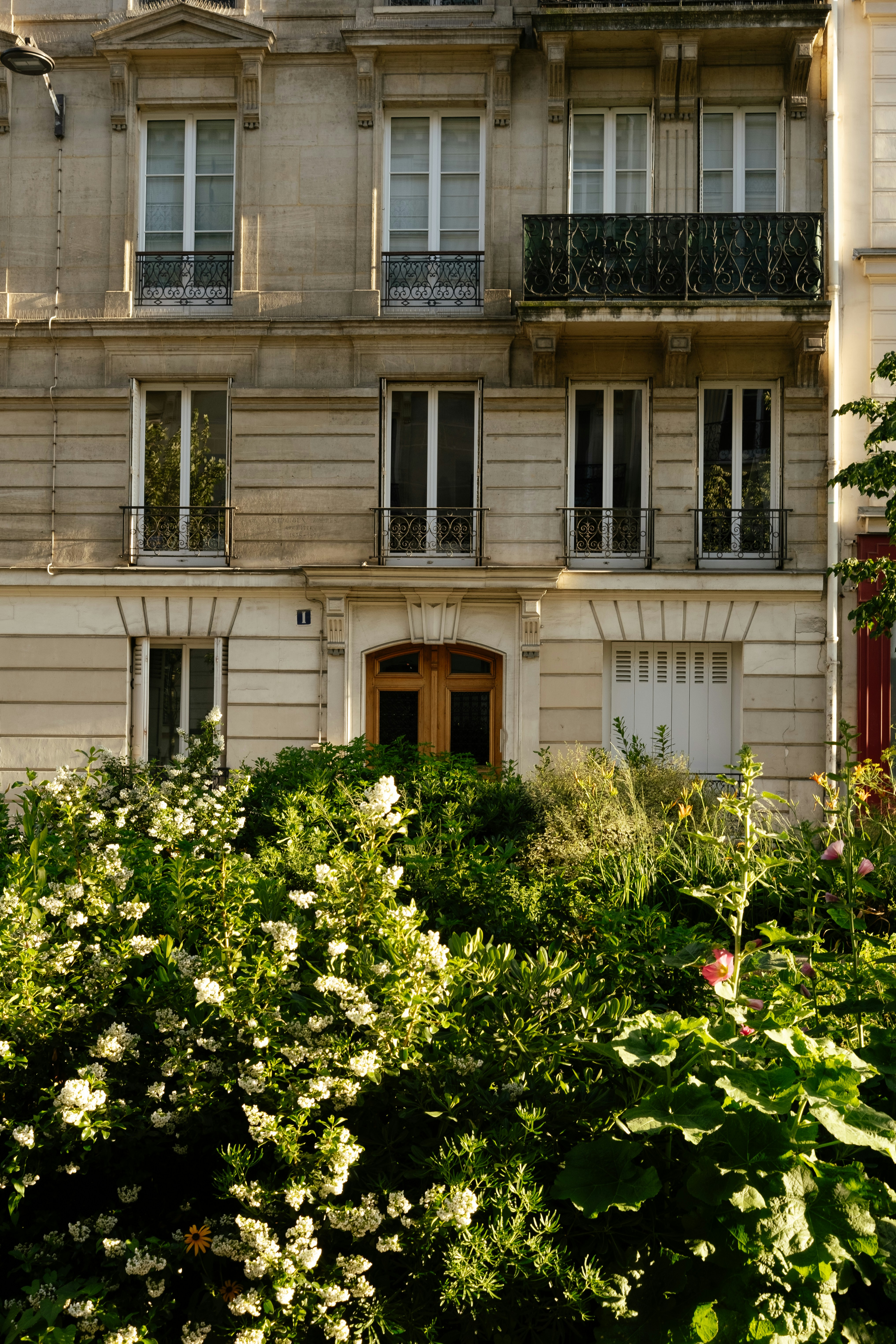 Urban Facade in Bloom: A Parisian Residence Framed by Gardened Ground