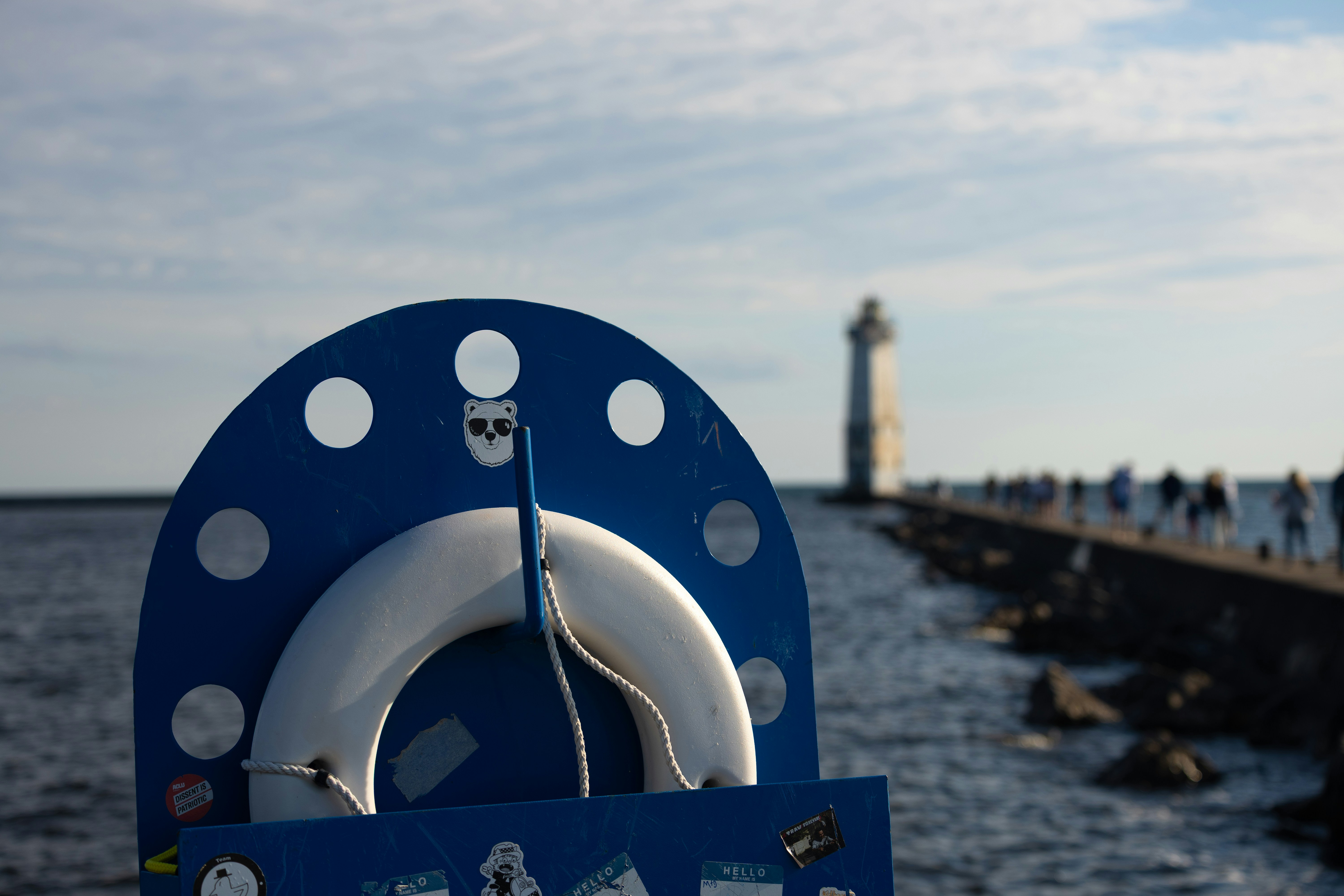 Public Wharf Signage Framing a Distant Lighthouse