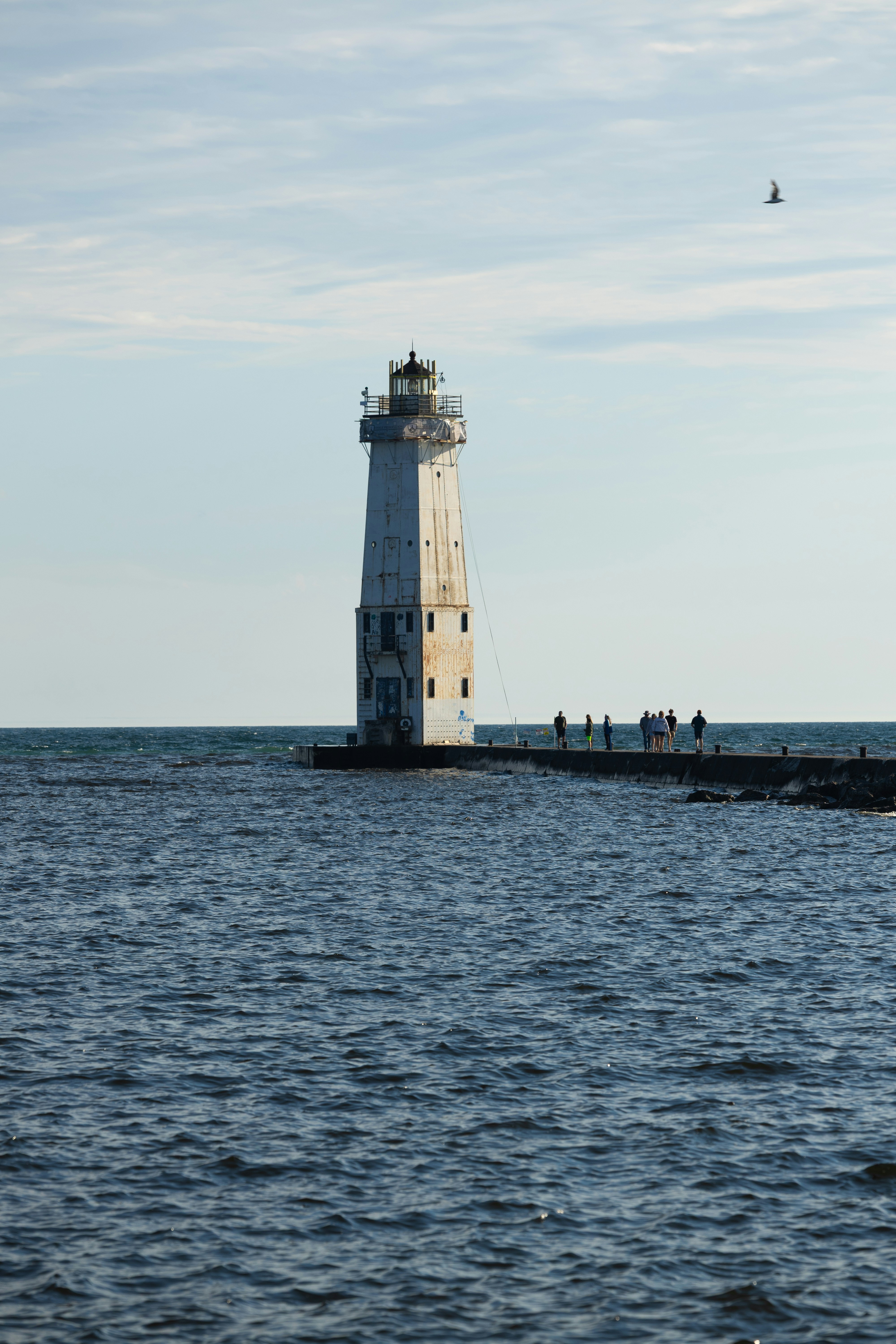 Lighthouse on the Pier: Sentinel over Quiet Seas