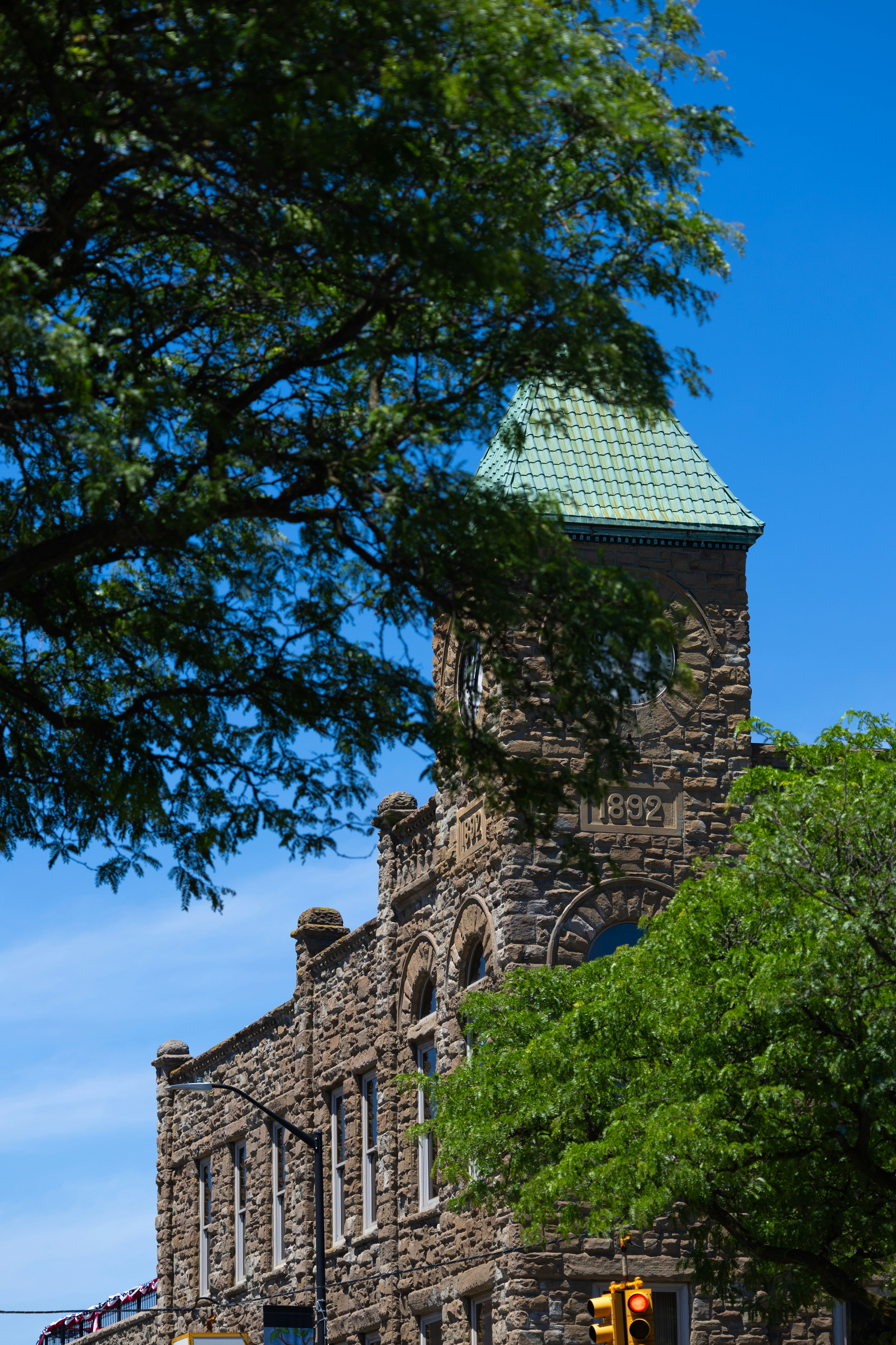 Stone Clocktower Under a Quiet Blue Sky