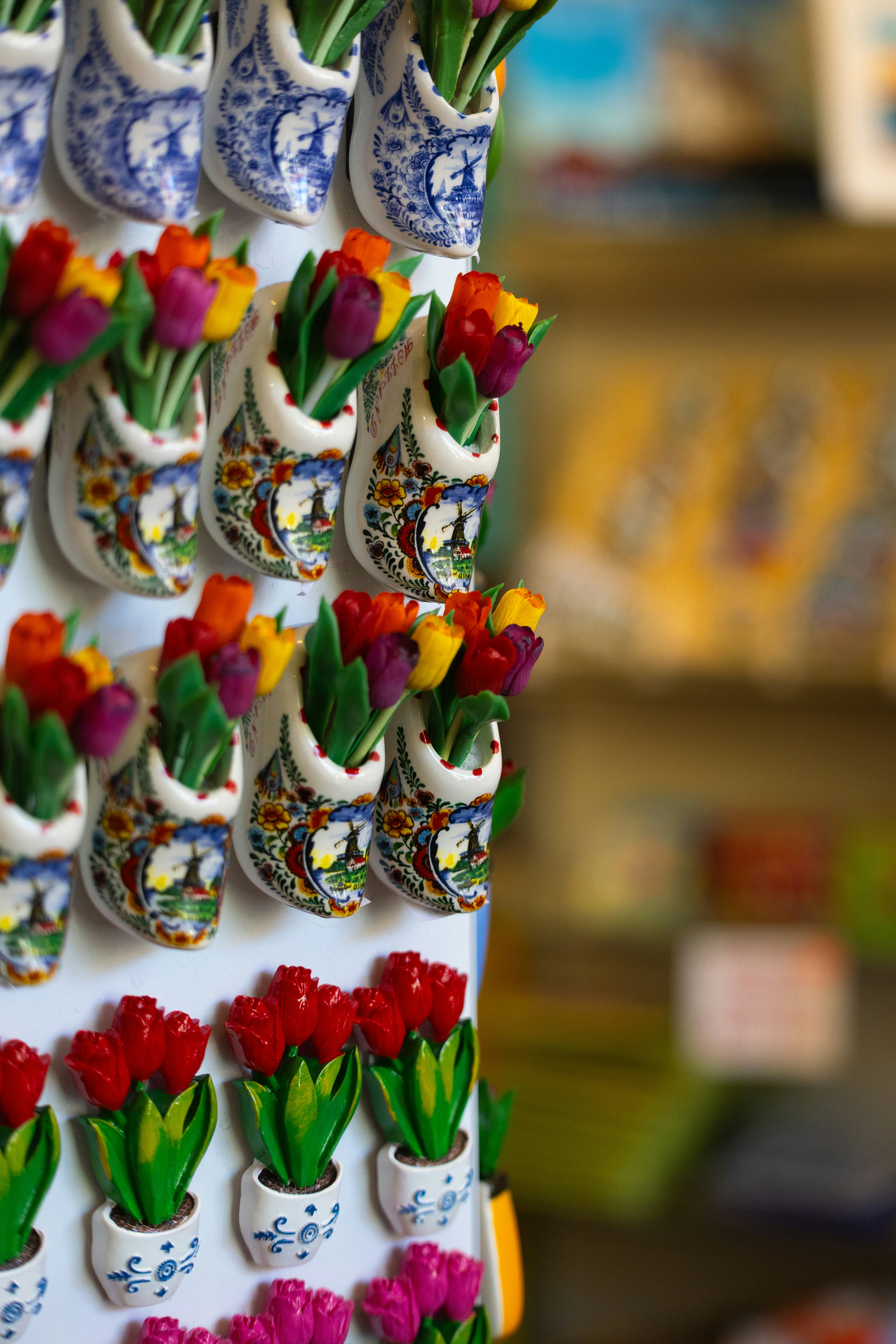 Row of Delft-style Tulip Vases: Colorful Ceramic Bottles Line a Display Wall