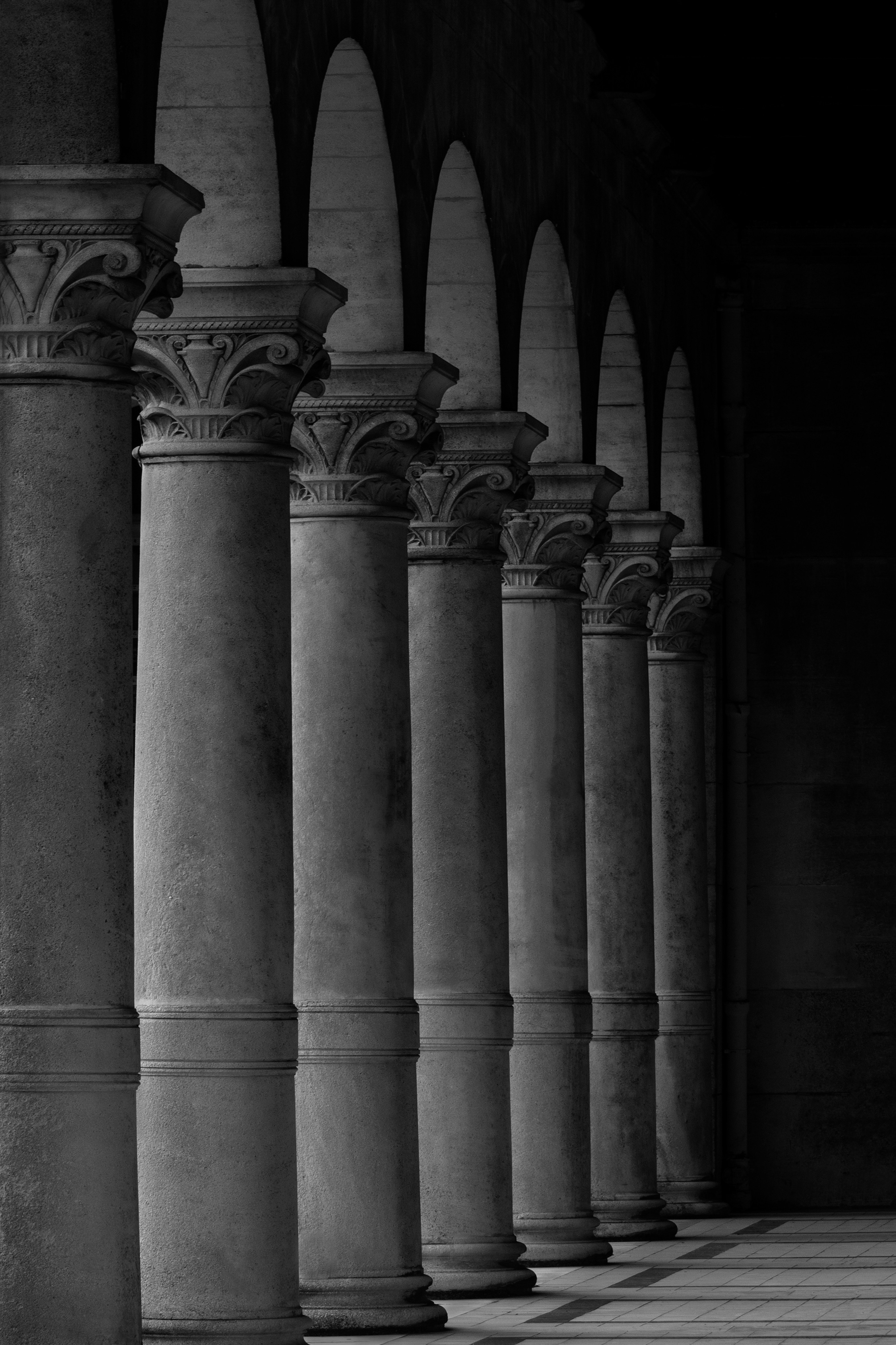 Archway Arcades: A Row of Monolithic Columns in Shadows