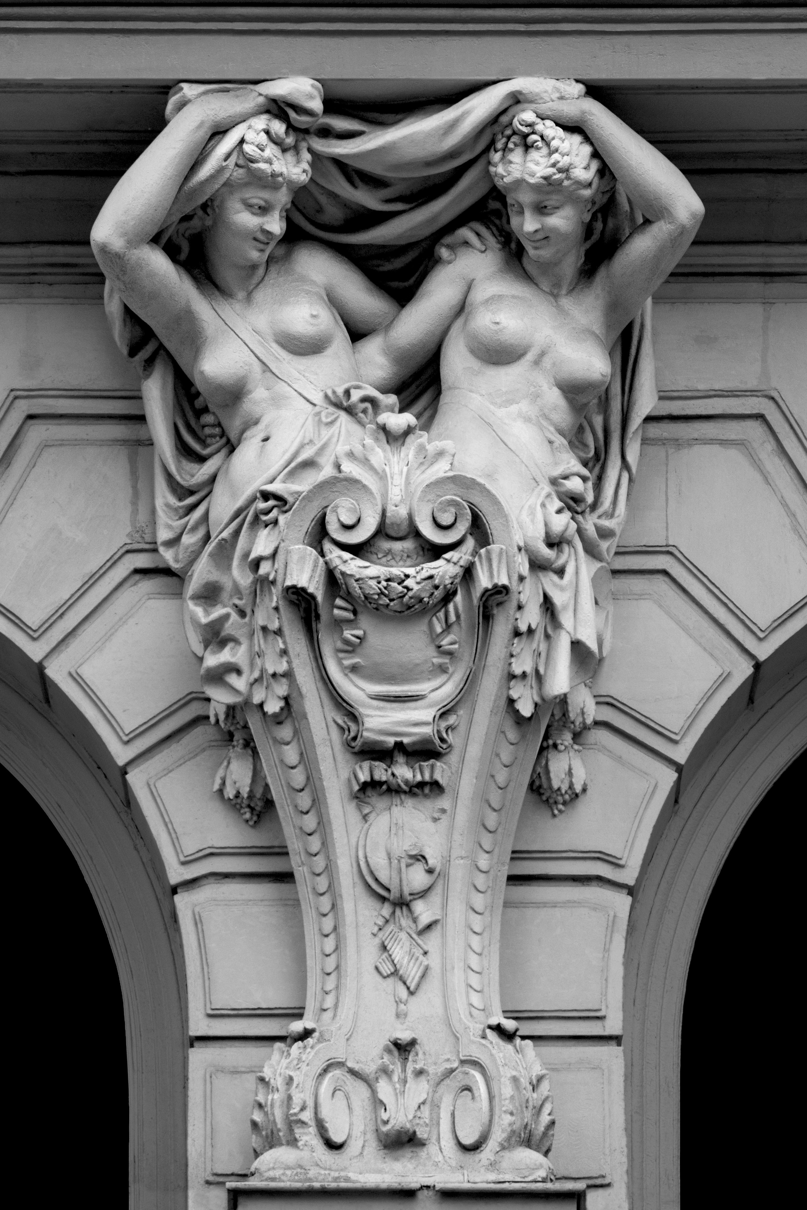 Guardians of Stone: Double Nudes Carved Above the Arch