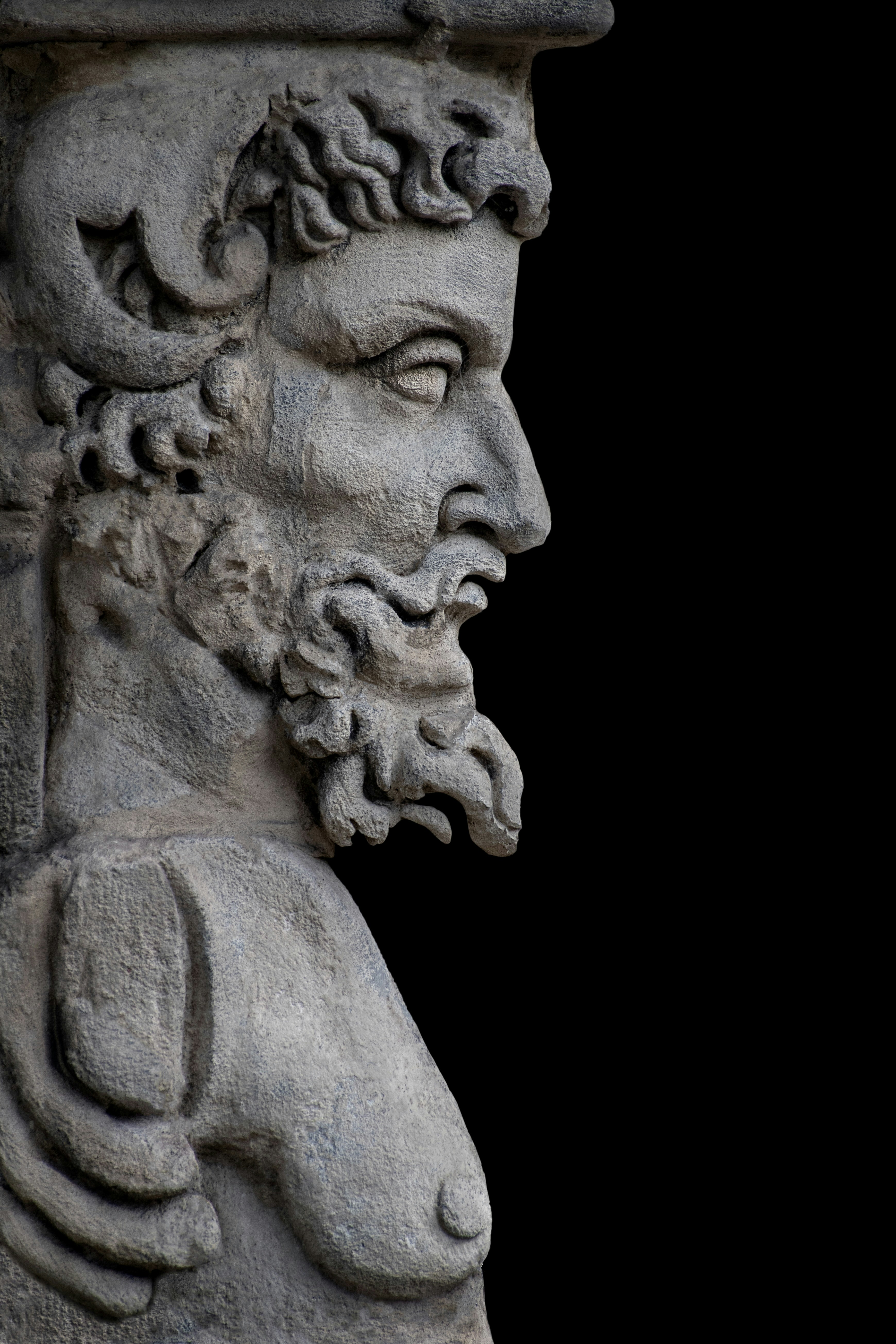 Stone Messenger: A Sculpted Portrait in Shadowed Contrast