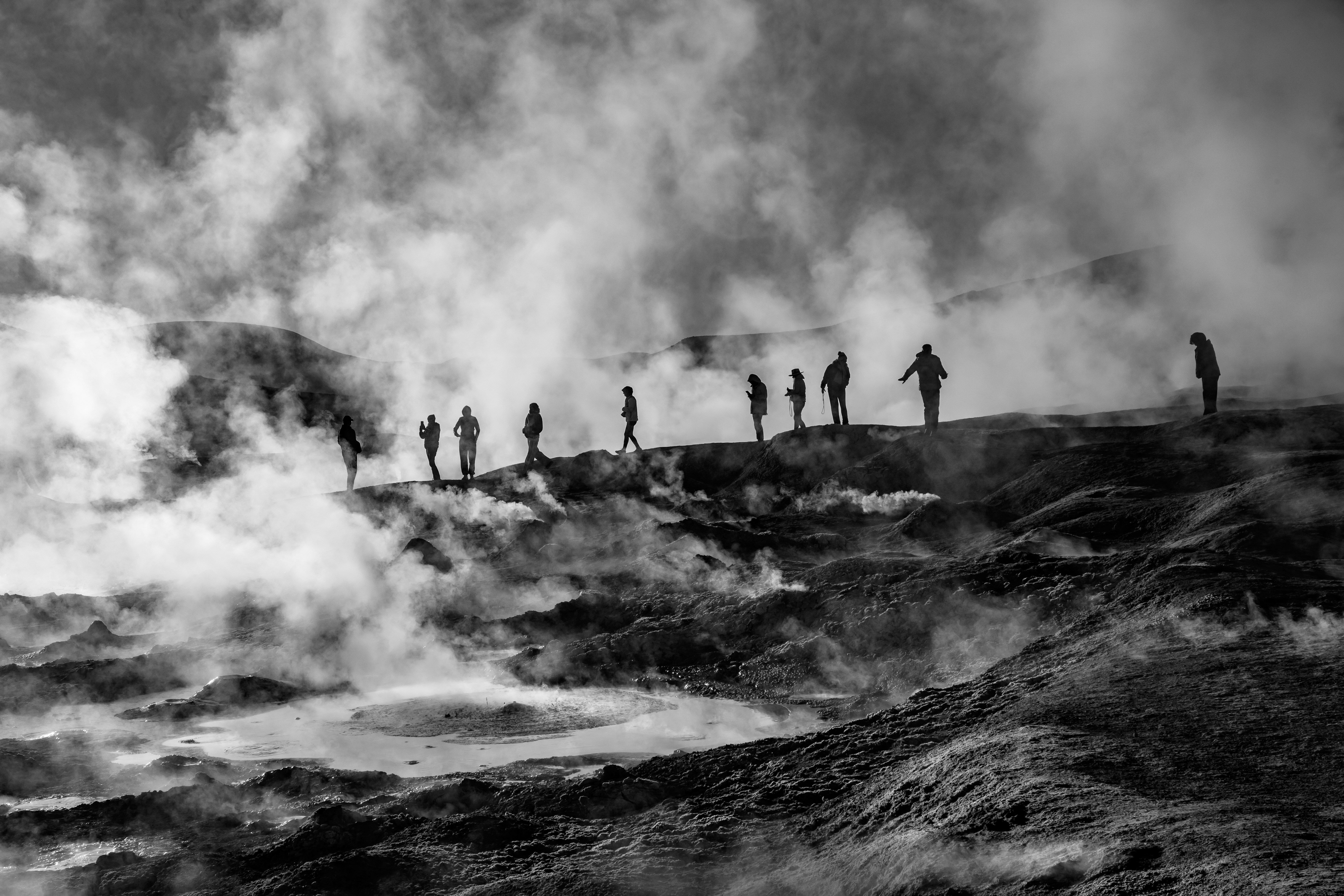 Steamward: silhouettes tracing a volcanic rim