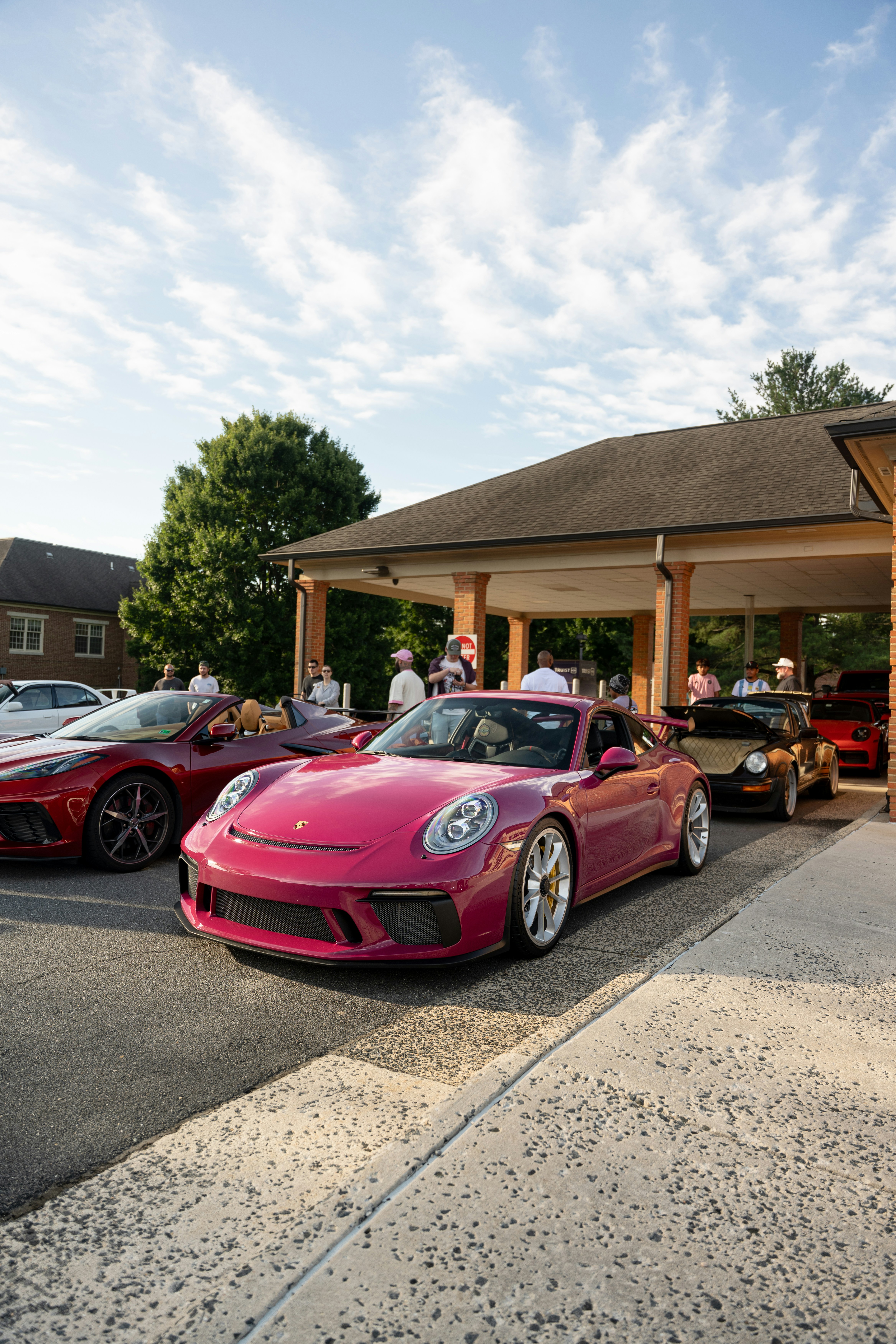 Pink Porsche Parade Under a Sunny Carport
