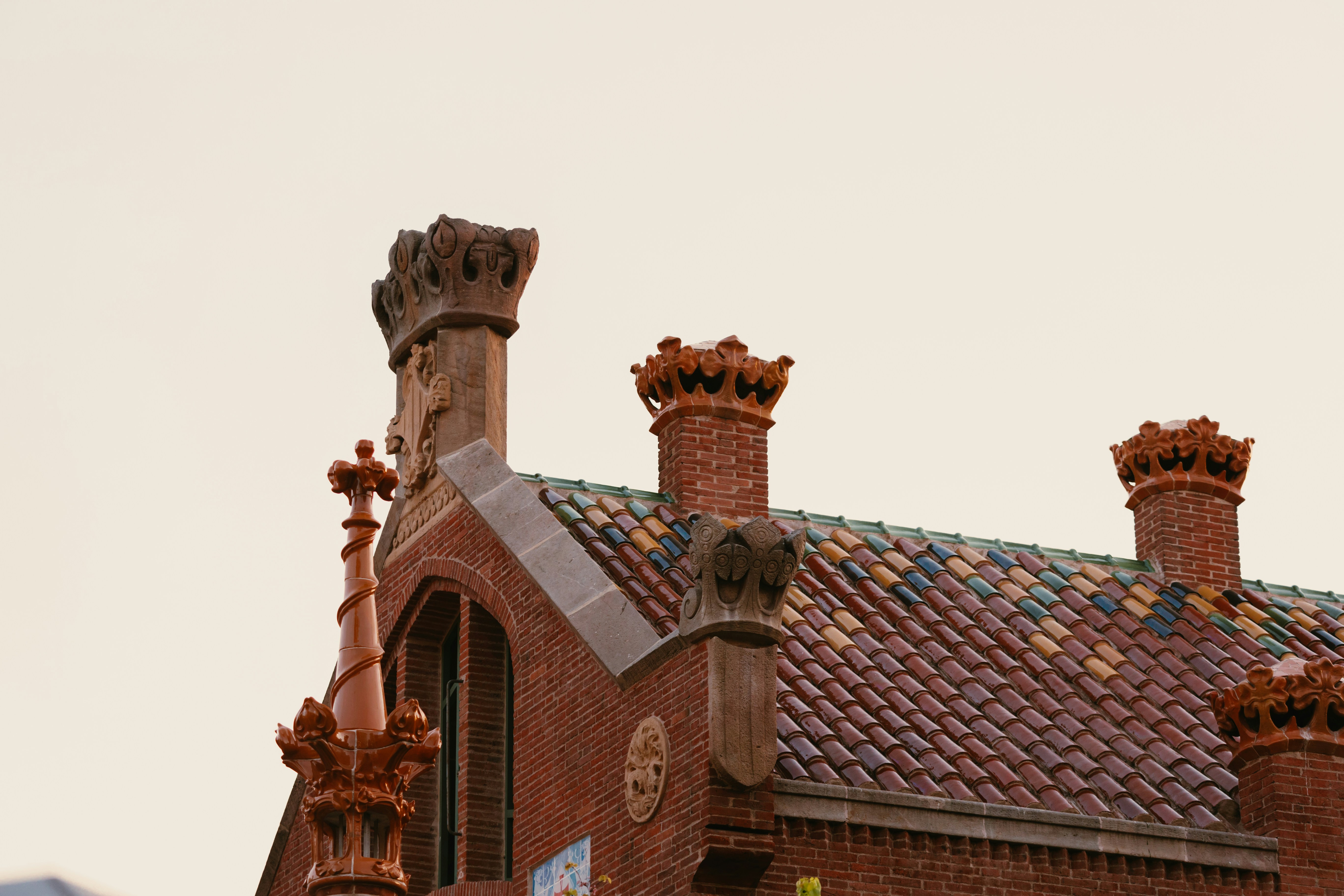 Architectural Crown: Ornate Brickwork and Tile Roof Peaks