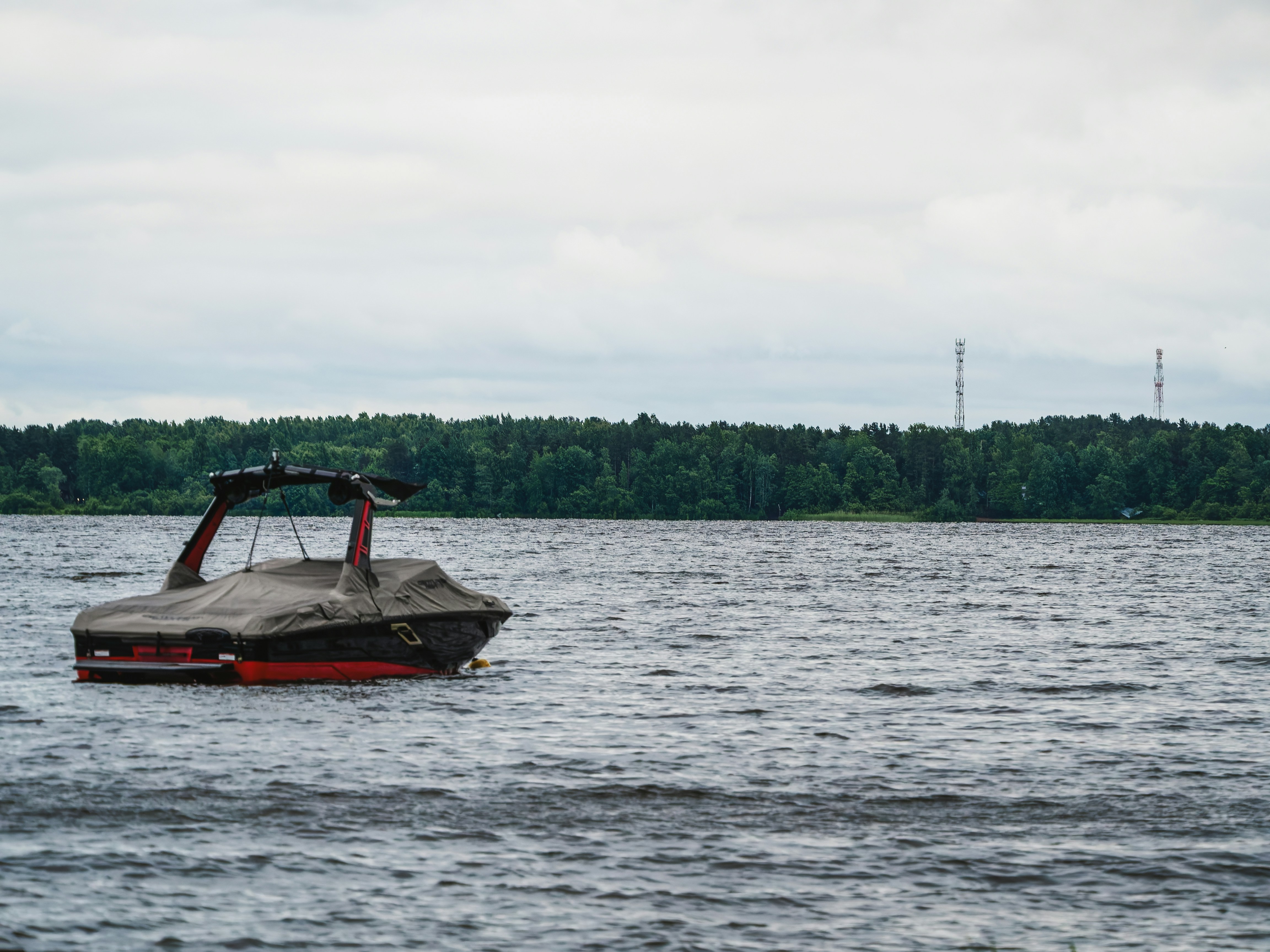 Red-edged Jet Boat Quietly Skims a Windy Lake