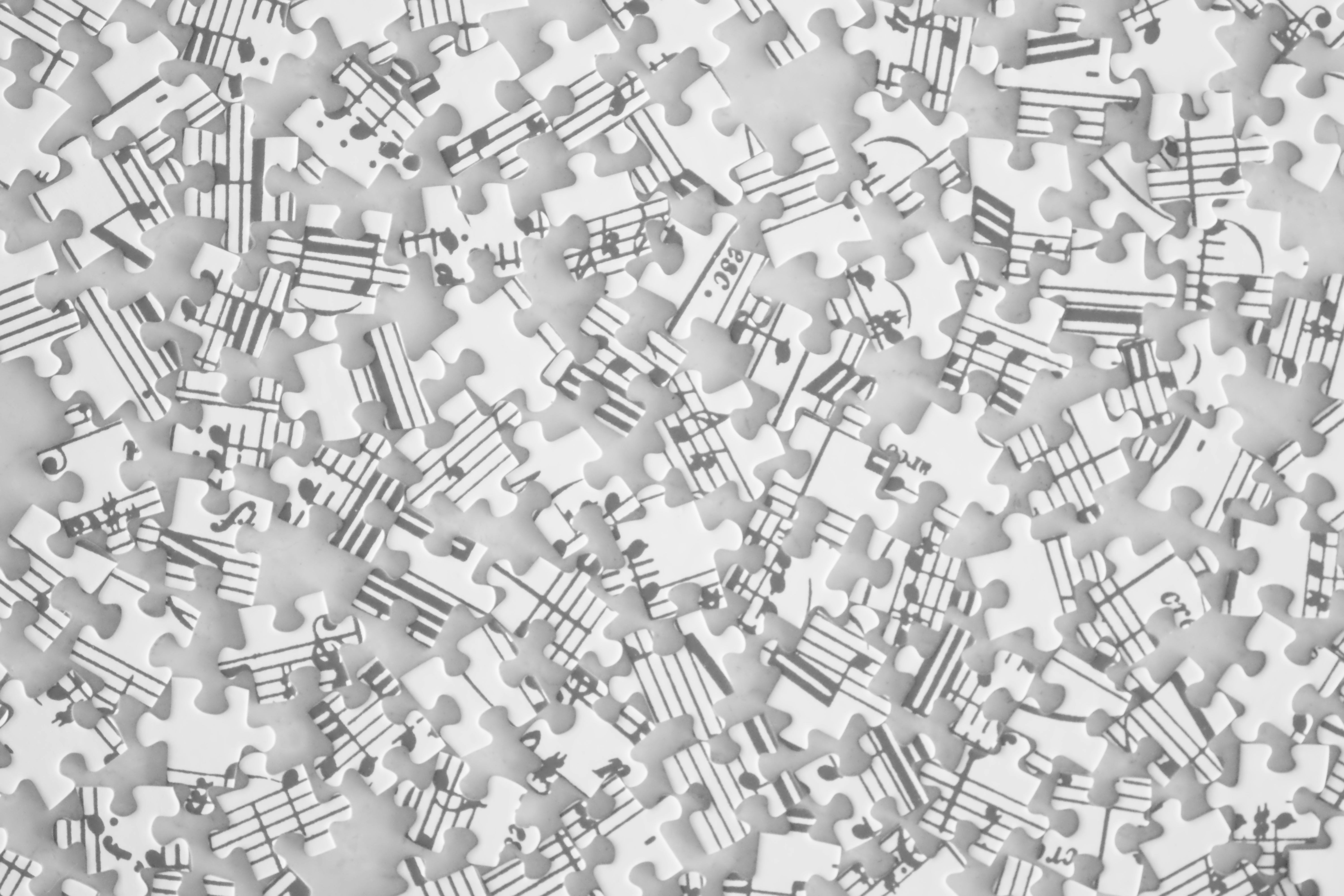 Overlapping Puzzle Pieces: A Monochrome Mosaic of Interlocking Shapes