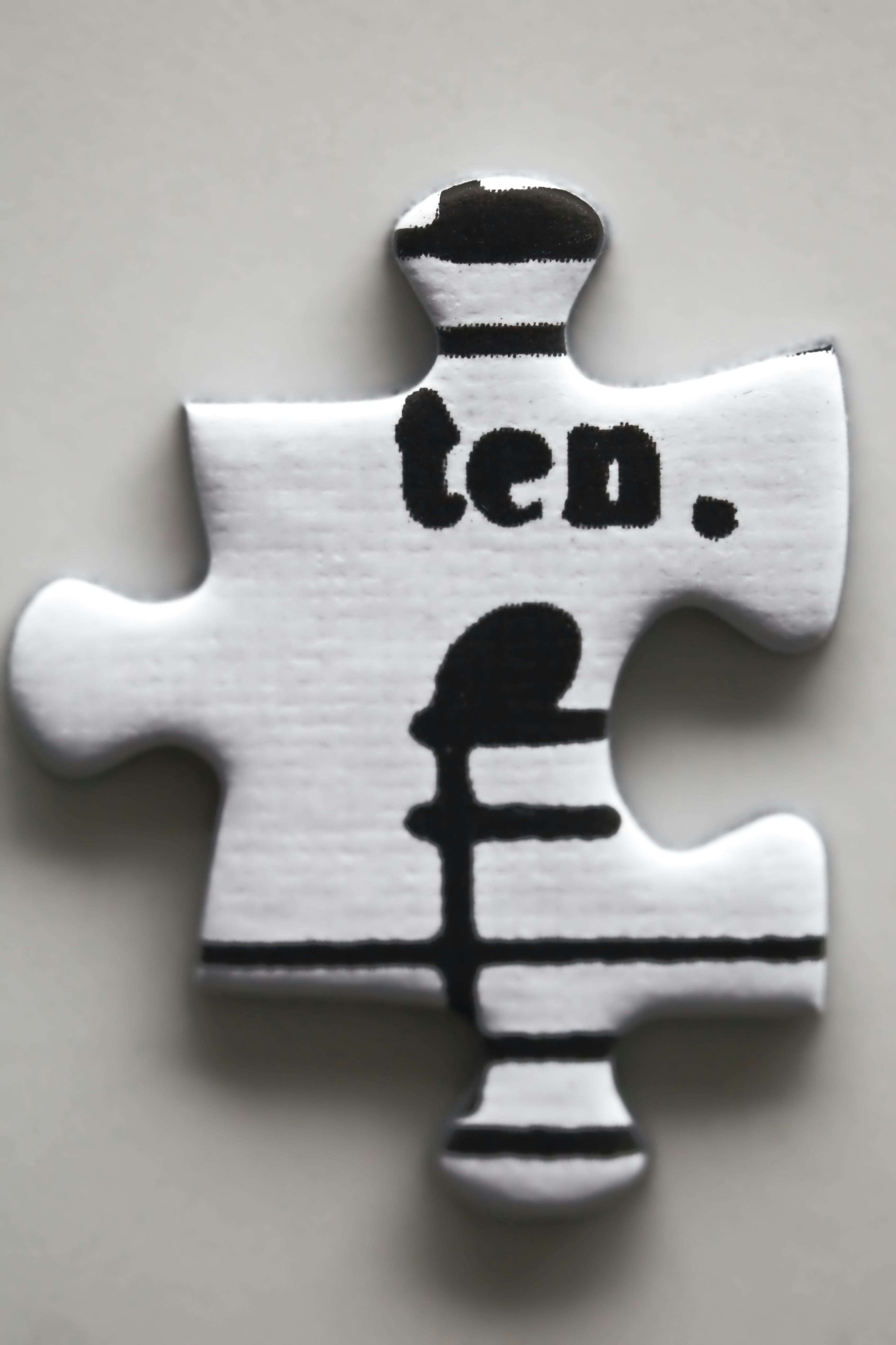 A white puzzle piece with the word "ten." on it.