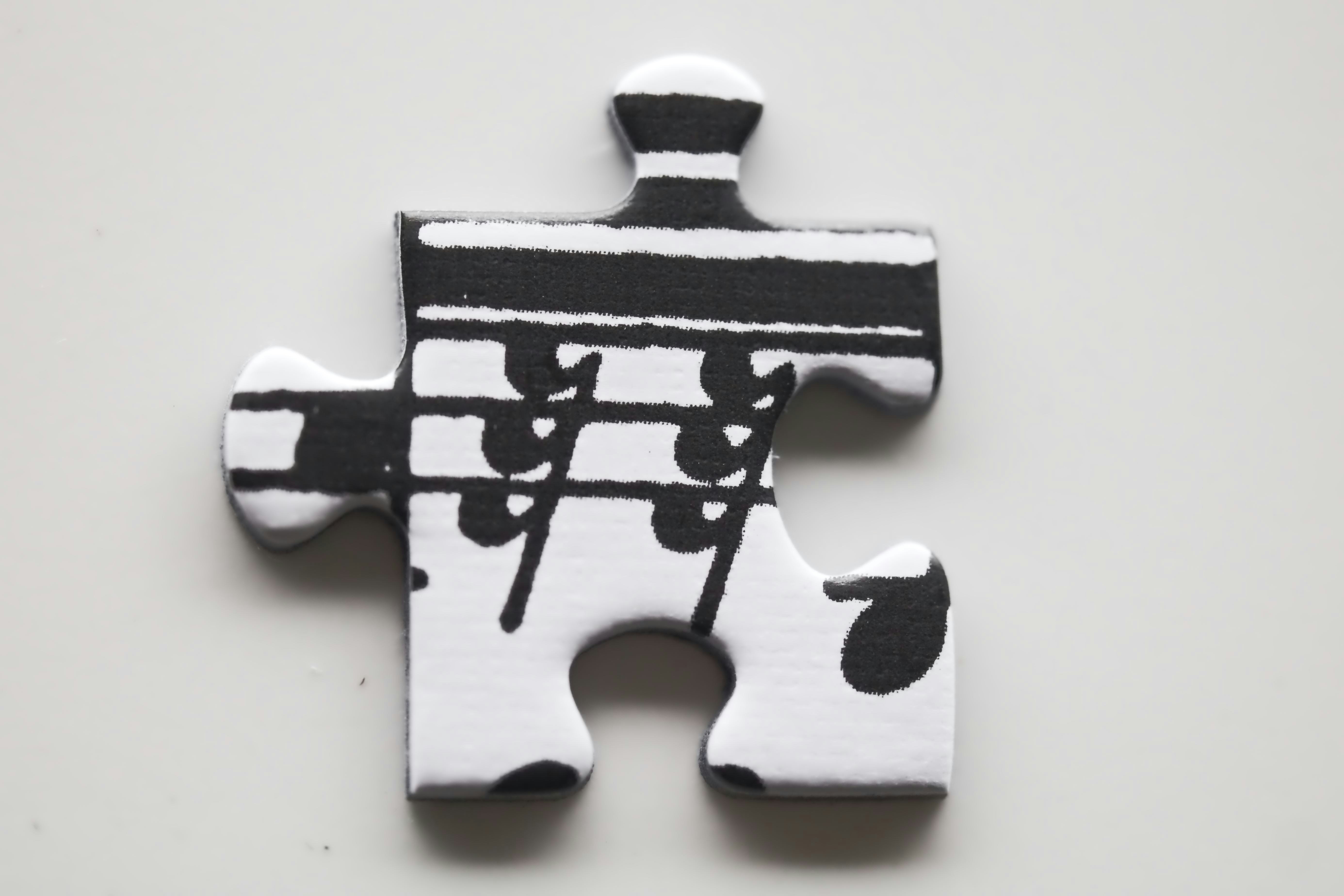 A puzzle piece with musical notes on a white background.