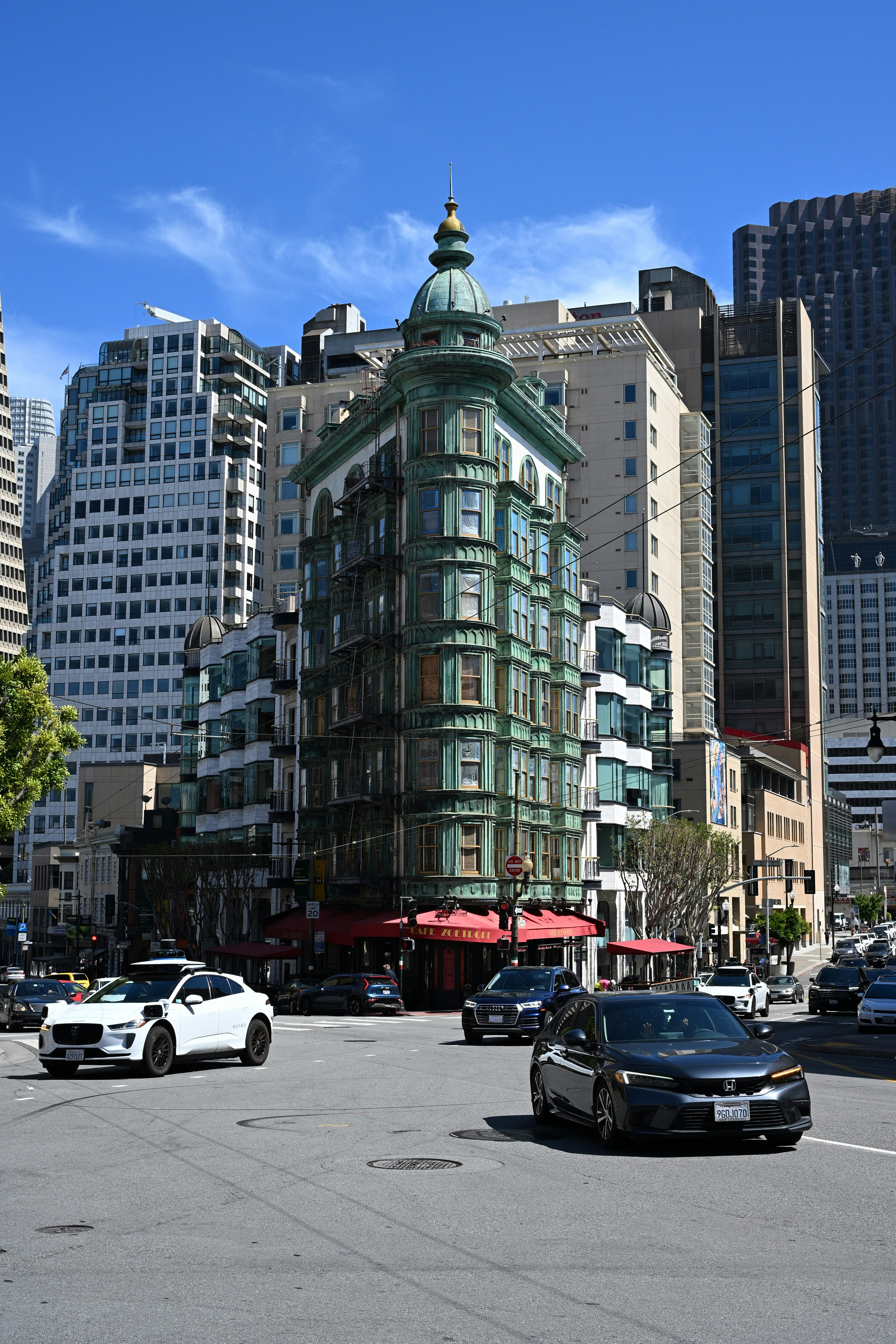 The Green Turreted Confluence: City Cornice Amid Modern Glass