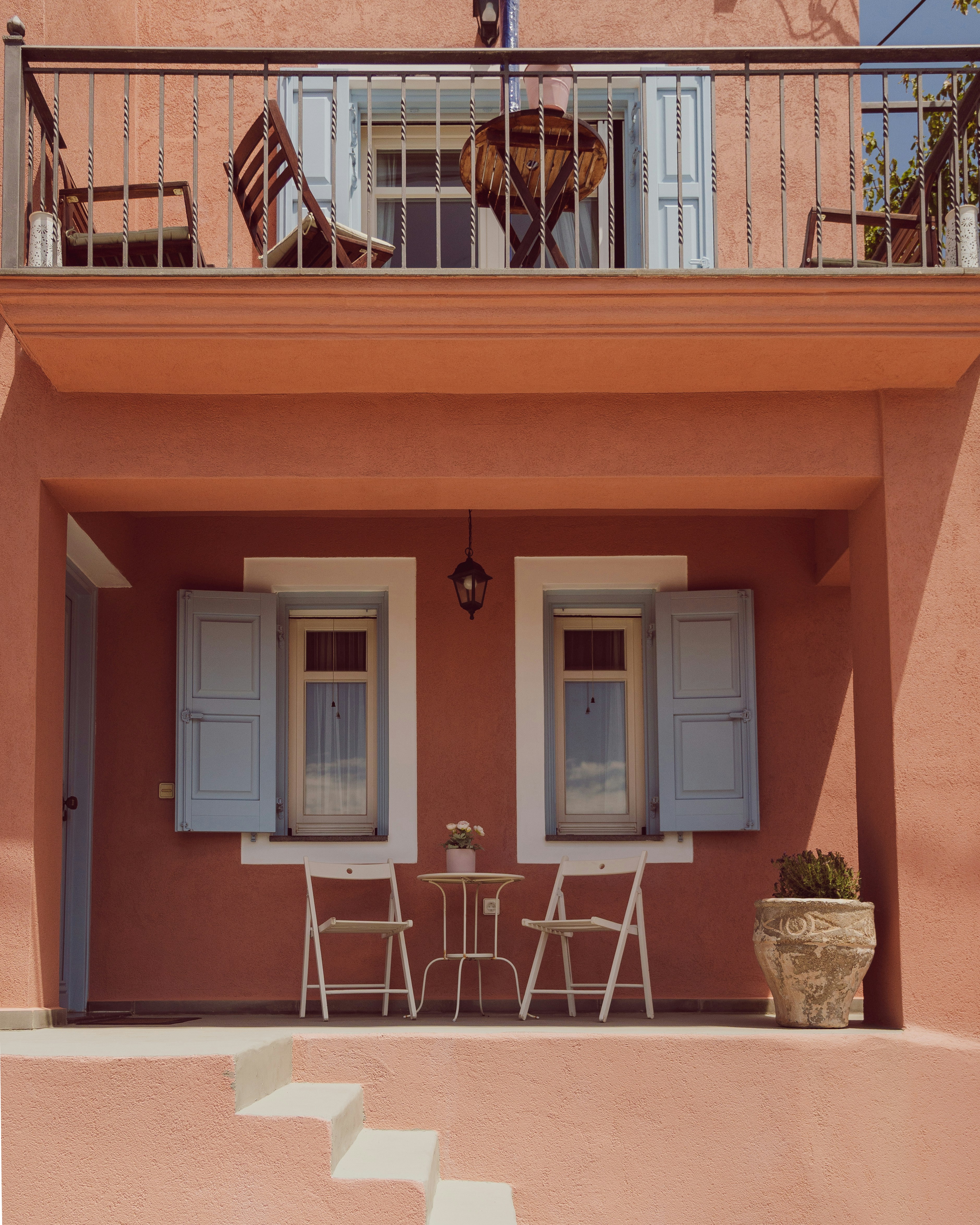 Terracotta Terrace: A Quiet Café Moment Under Pale Blue Shutters