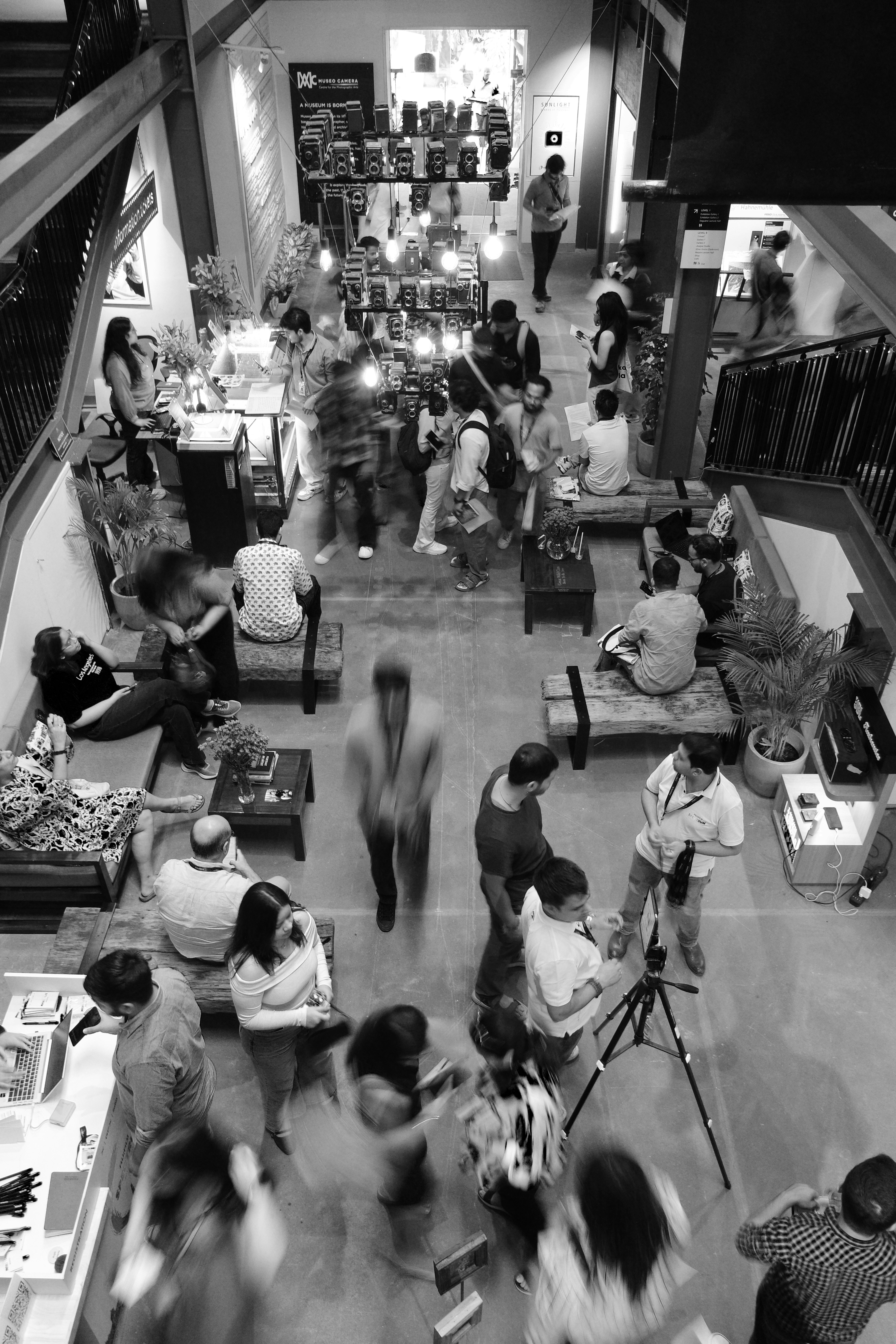 Crowded cafe gallery: a bustling mezzanine scene in monochrome