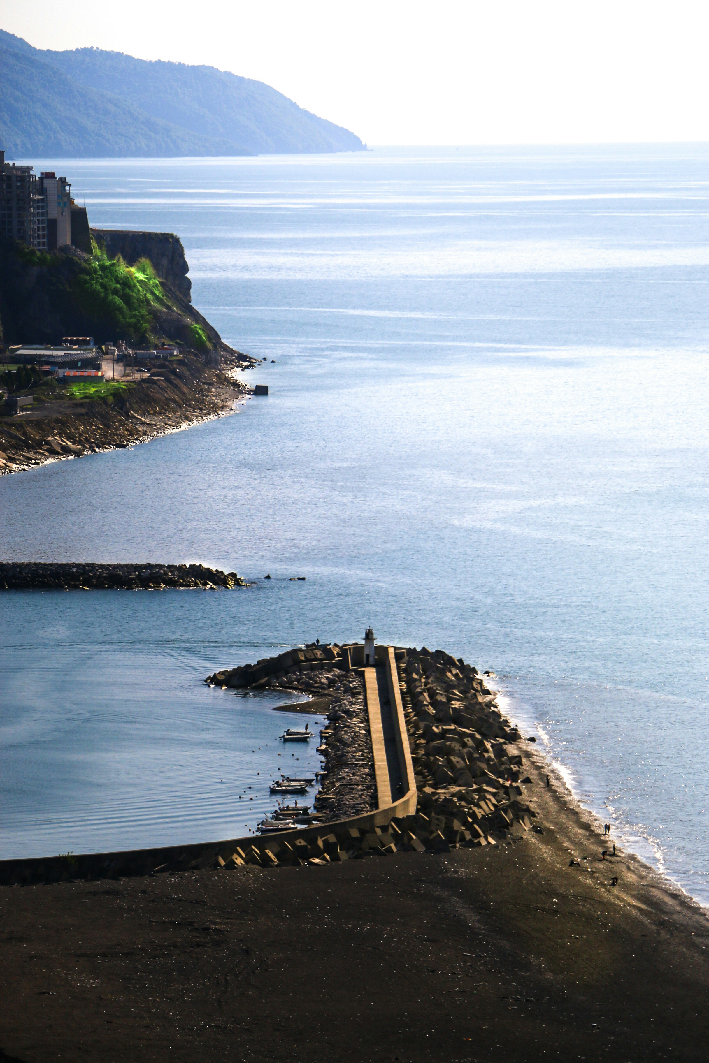 Sunlit Breakwater Reaching Toward the Open Sea