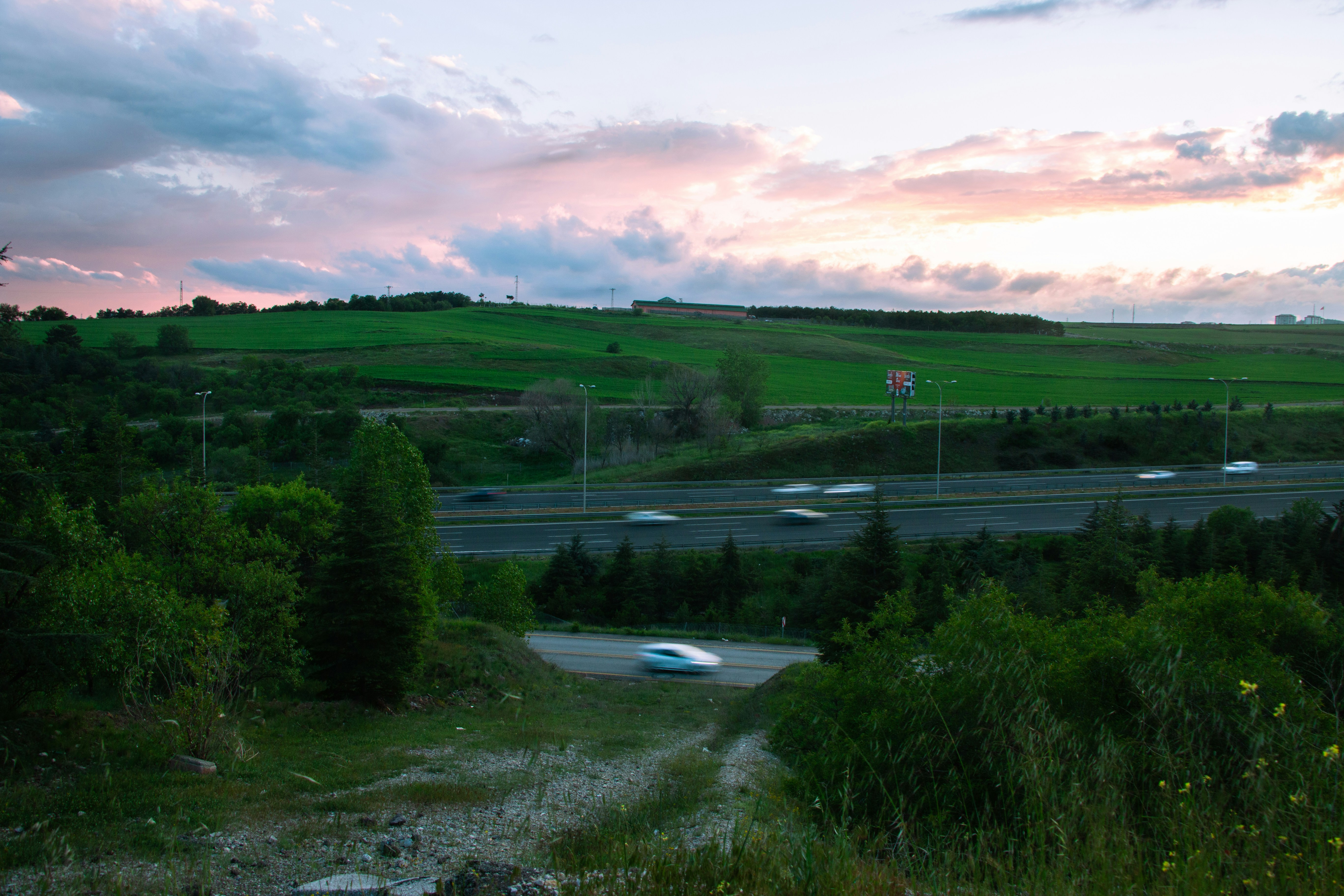 Evening on the Bends: Cars, Fields, and a Quiet Horizon
