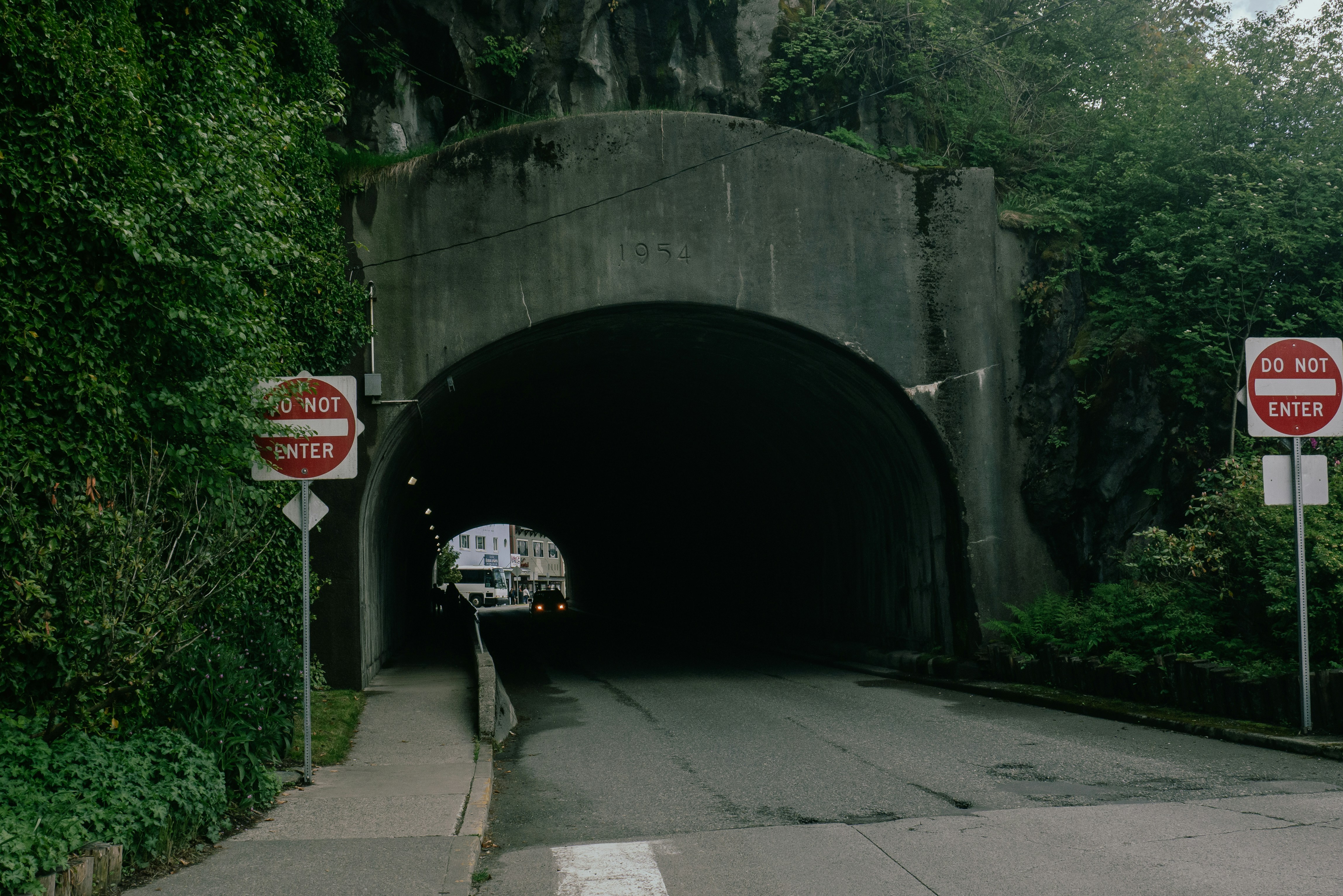 Dark Passage Beneath Green Arches