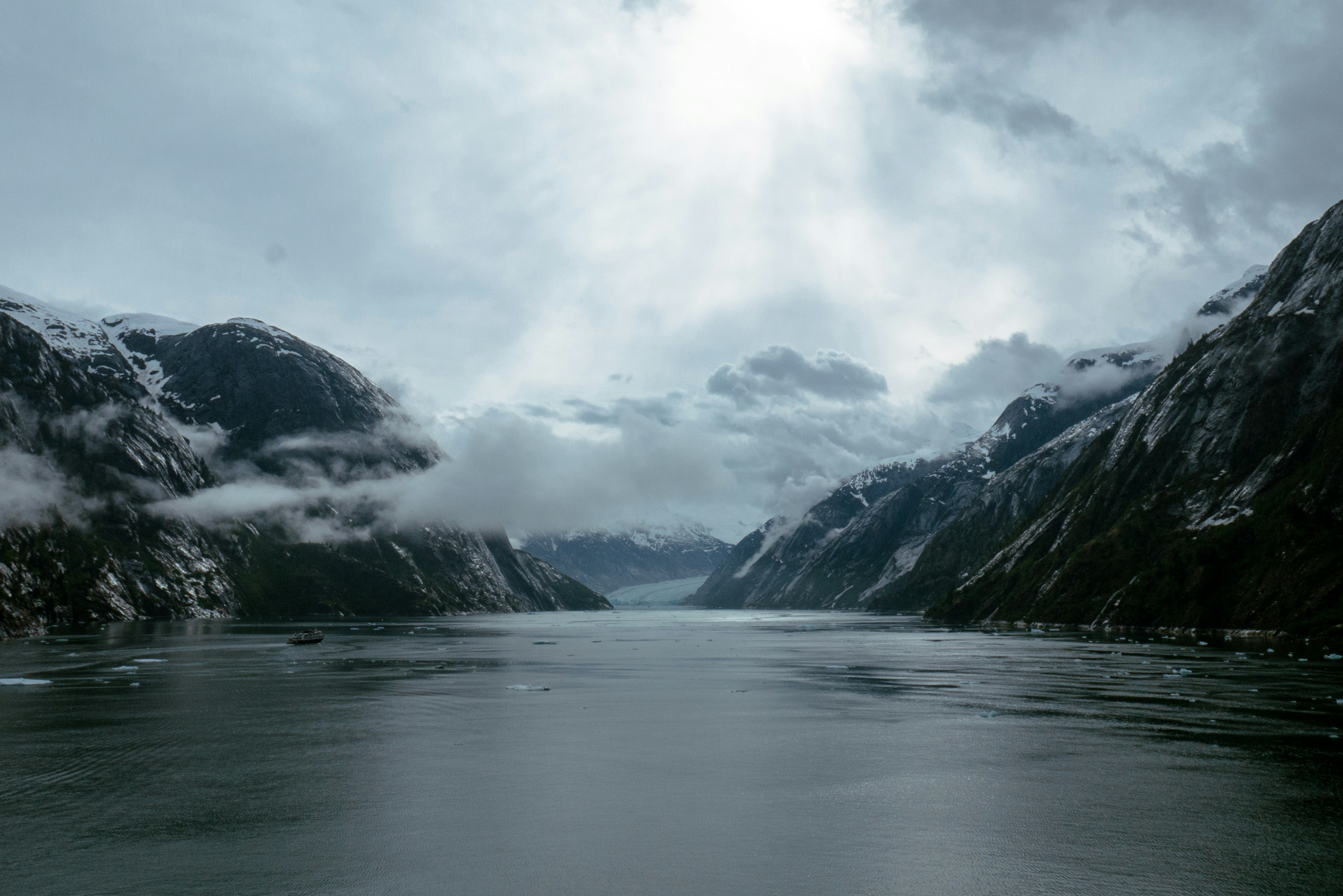 Glacial Fjord Reach: Light Breaking Through Overcast Peaks