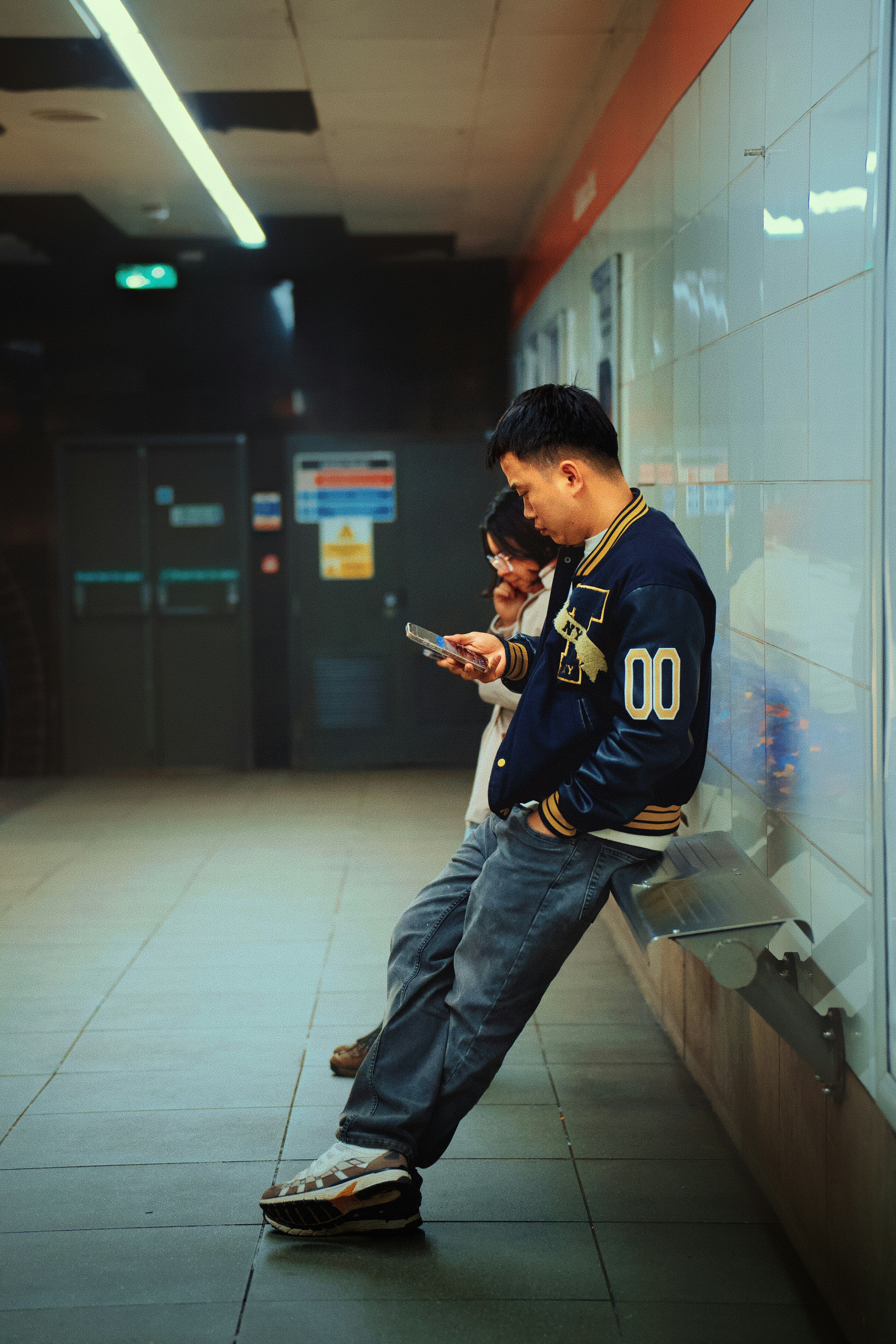 Quiet Neon Pause: Two Friends in a Subway Moment