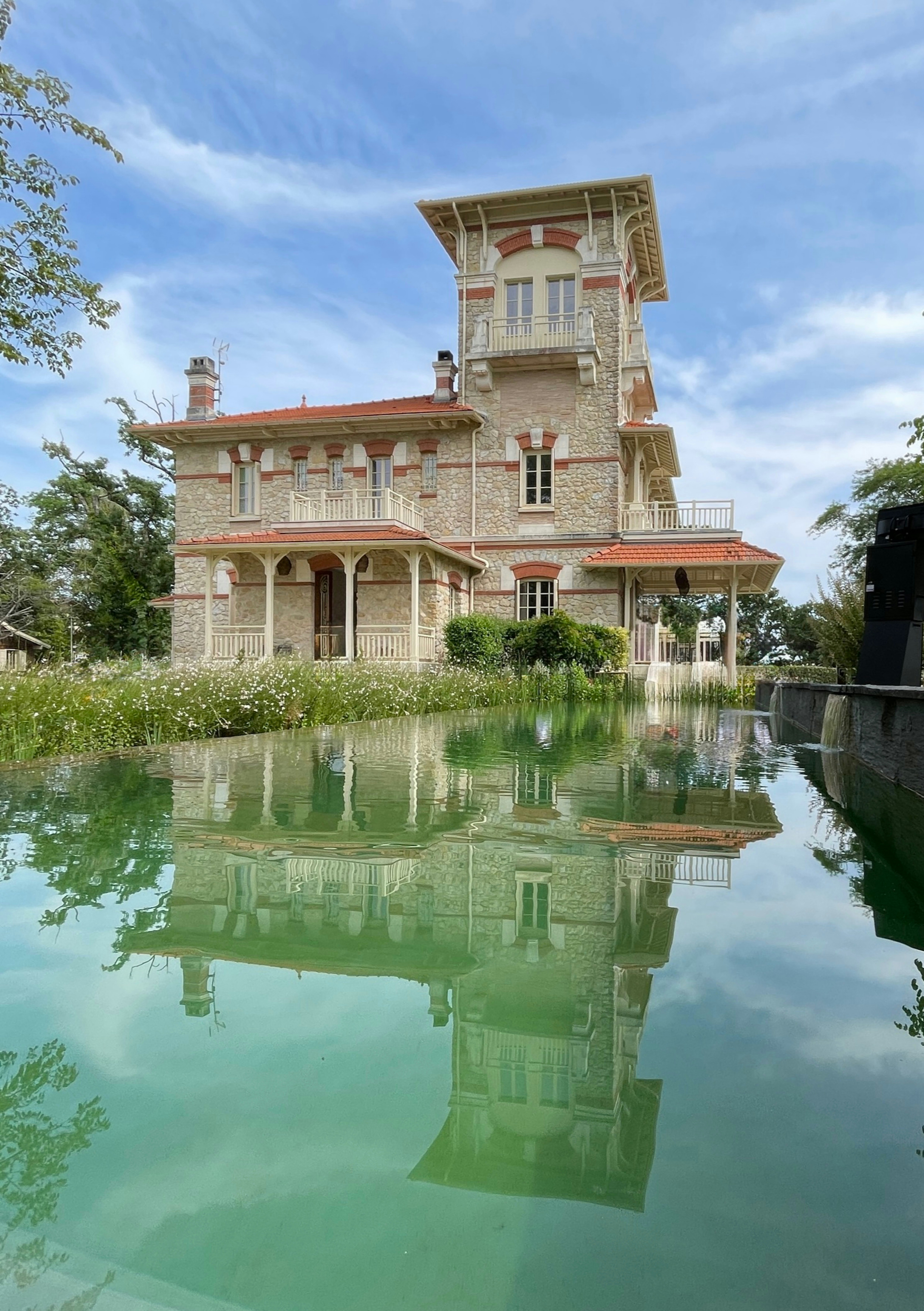 Reflected Grandeur: A Villa Rises from Quiet Water