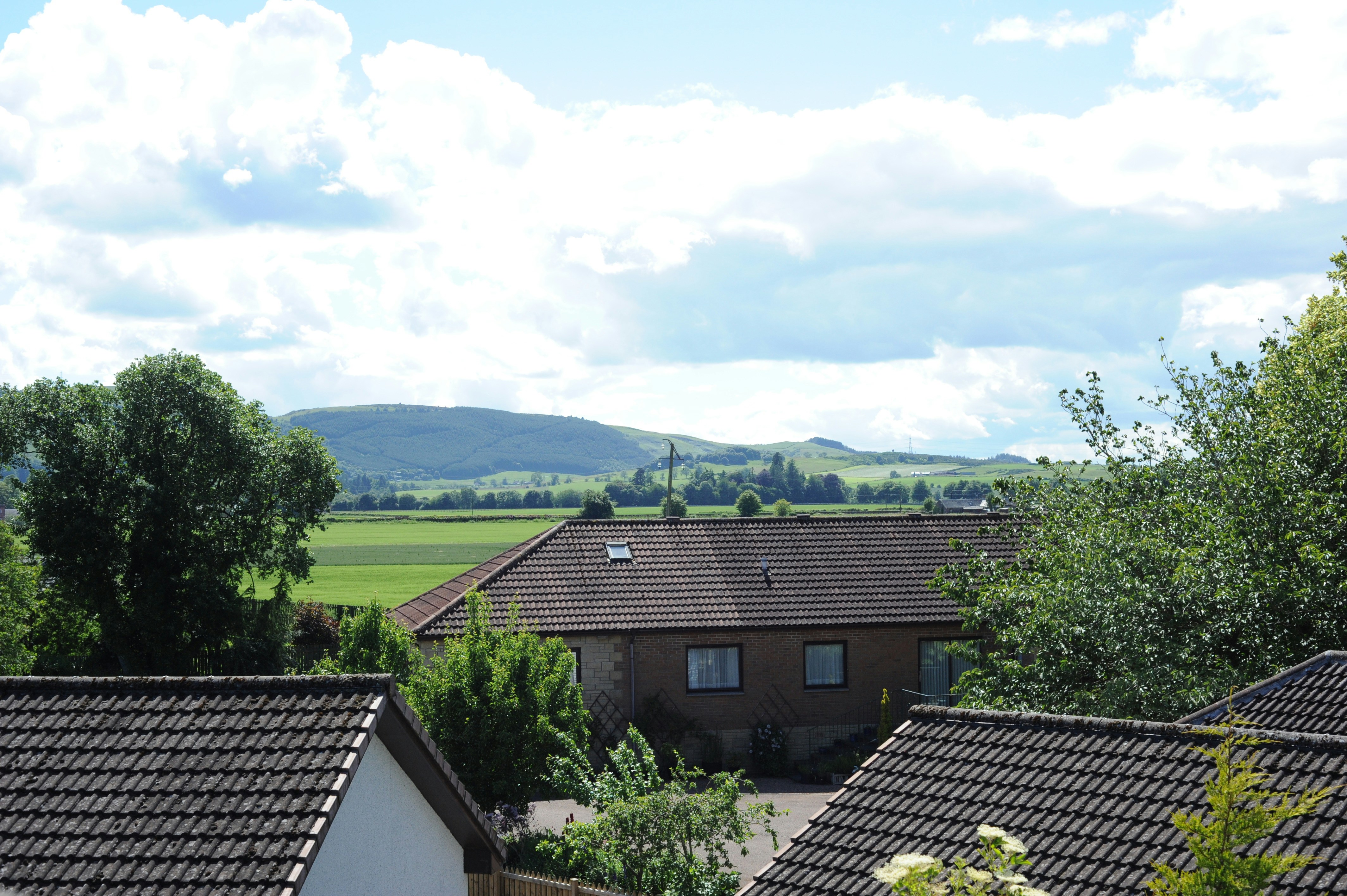 Sunlit Rooftops and Horizon Beyond the Village