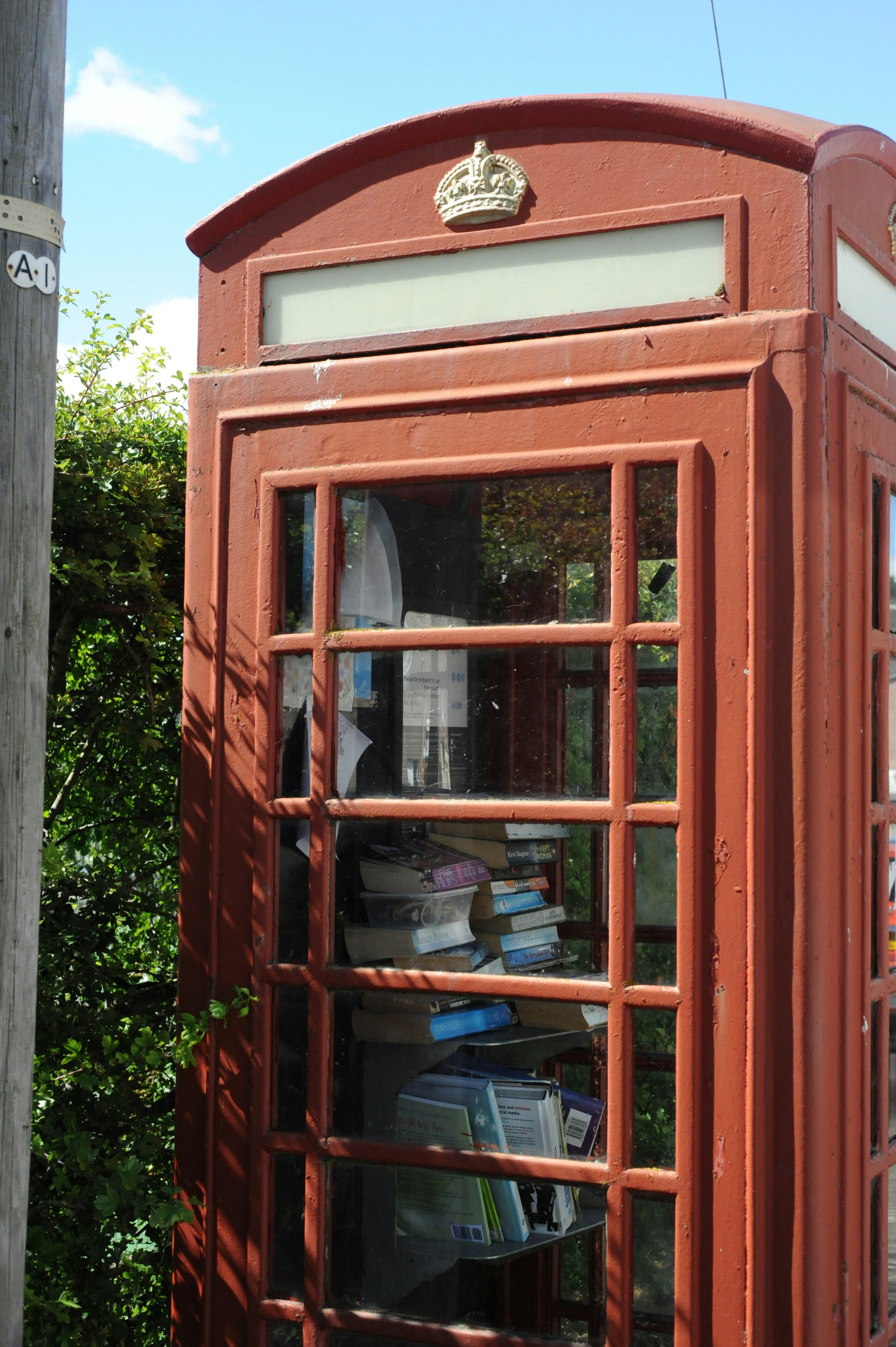 Red British Telephone Kiosk Reimagined as a Window into Books