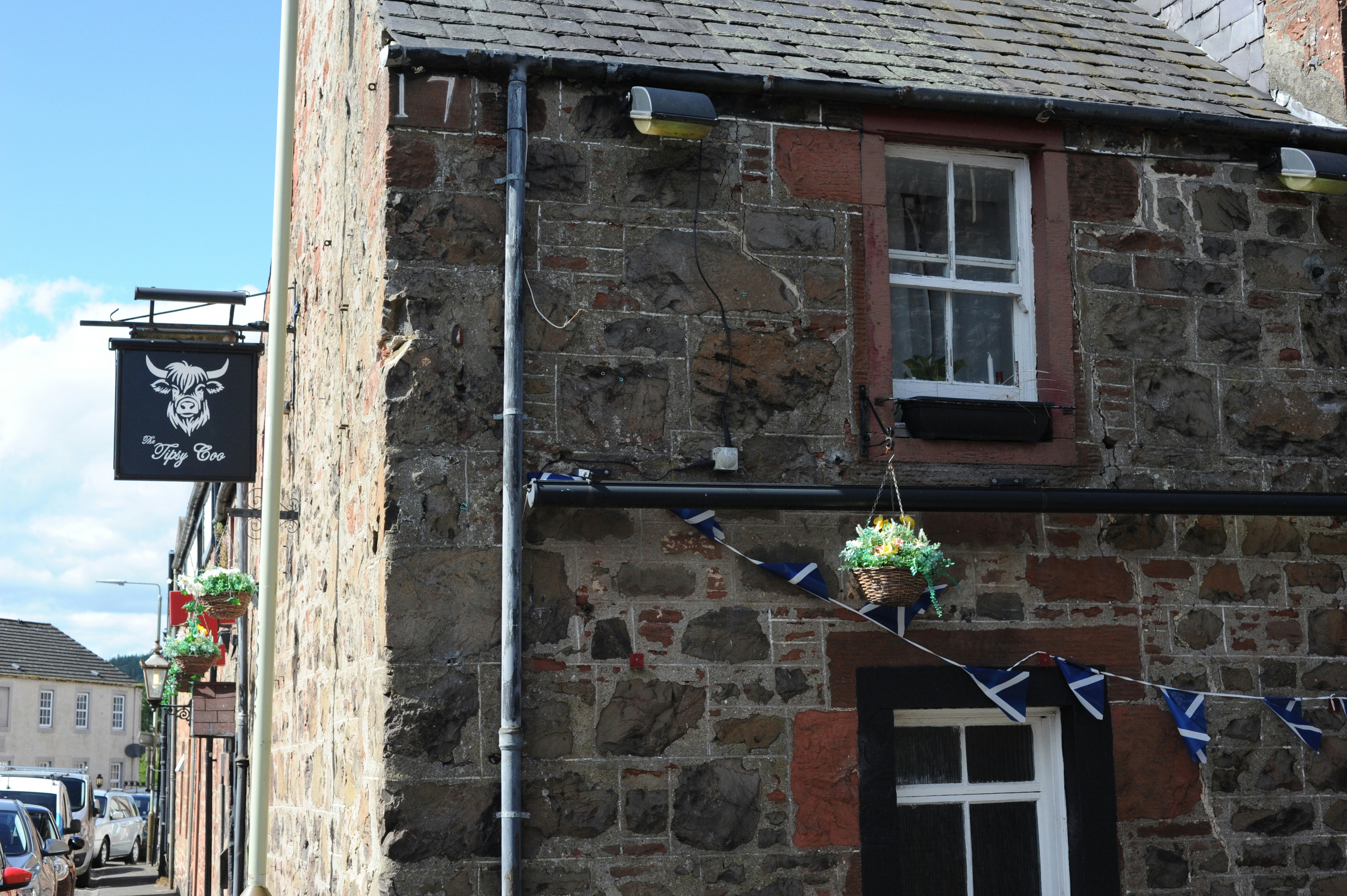 Stone Corner Inn: Bannered Street and Hanging Flower