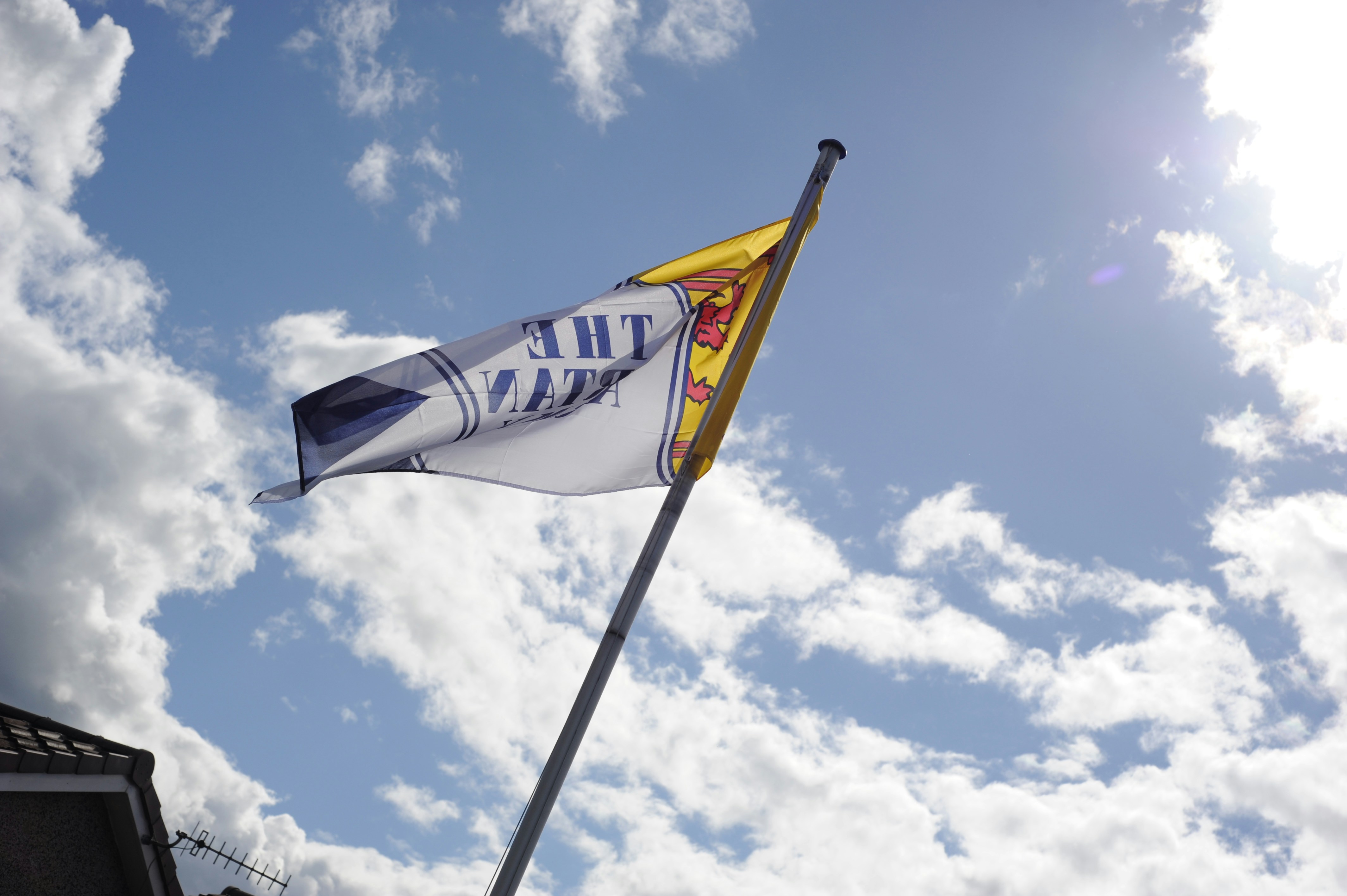 White and yellow flag waving under a bright, cloudy sky. photo – Free ...