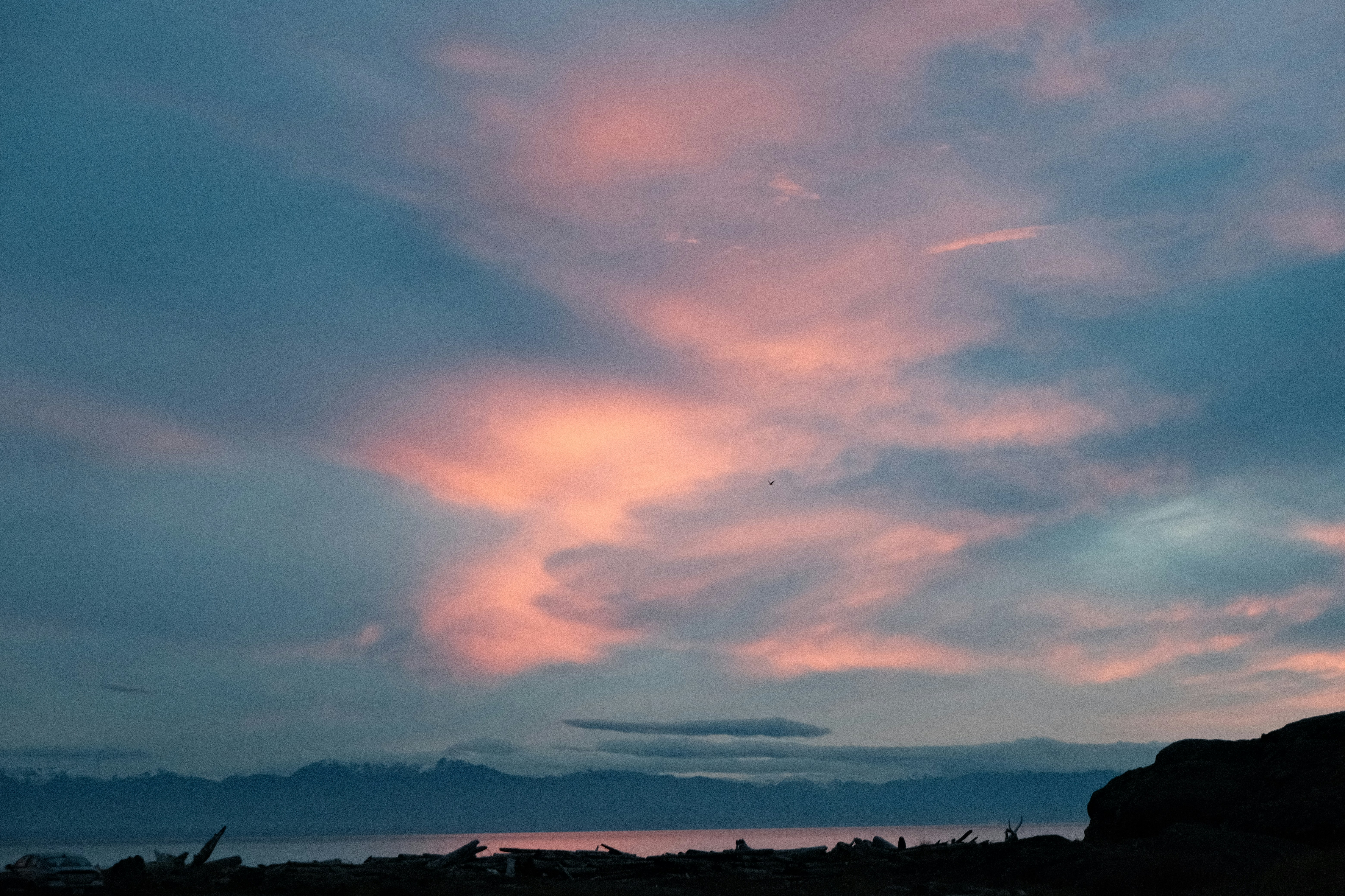 Dusk on the Horizon: Clouds Glow Over a Silent Shore