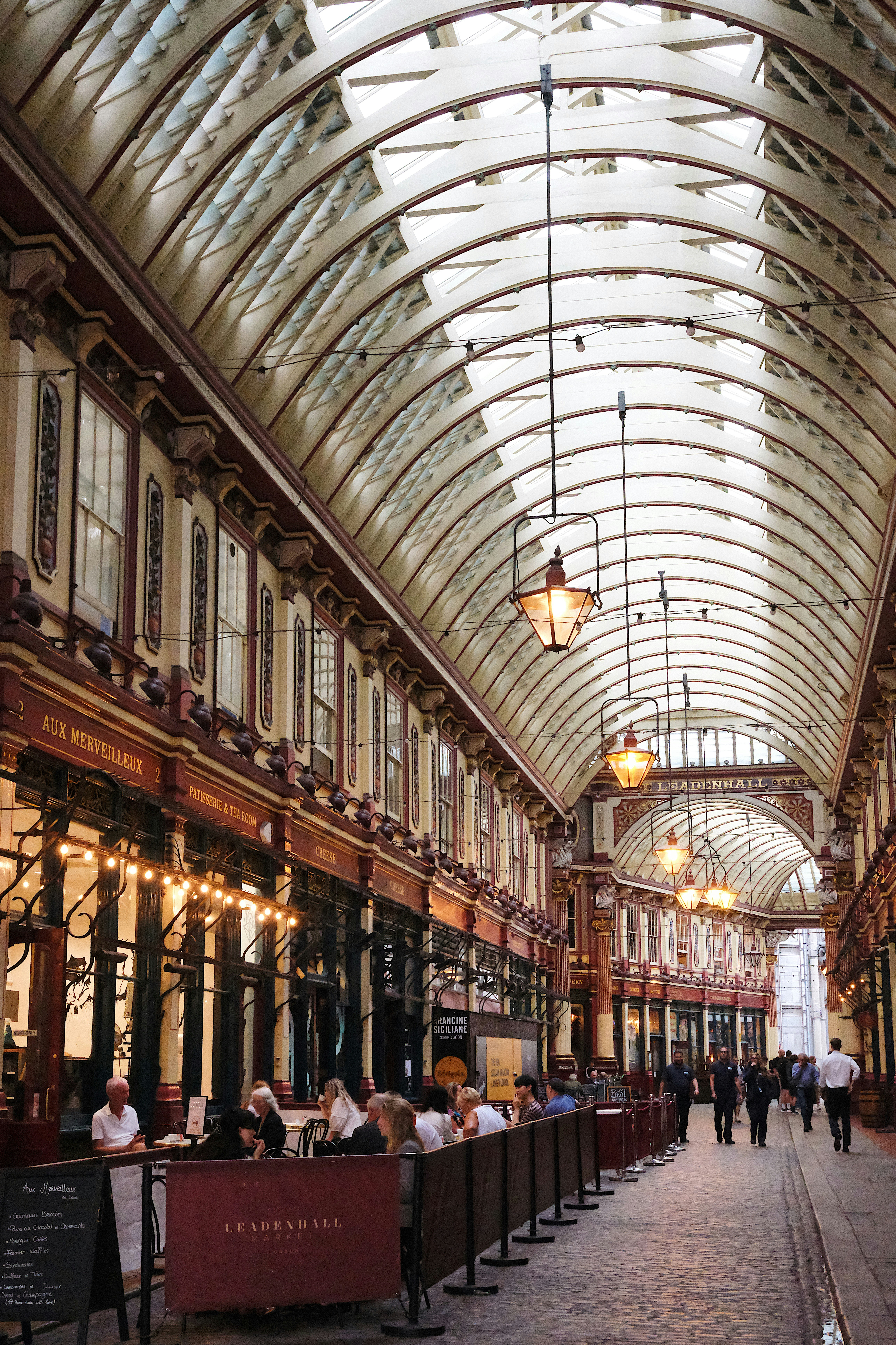 Cascading Glass Roof Over a Cobblestone Arcade