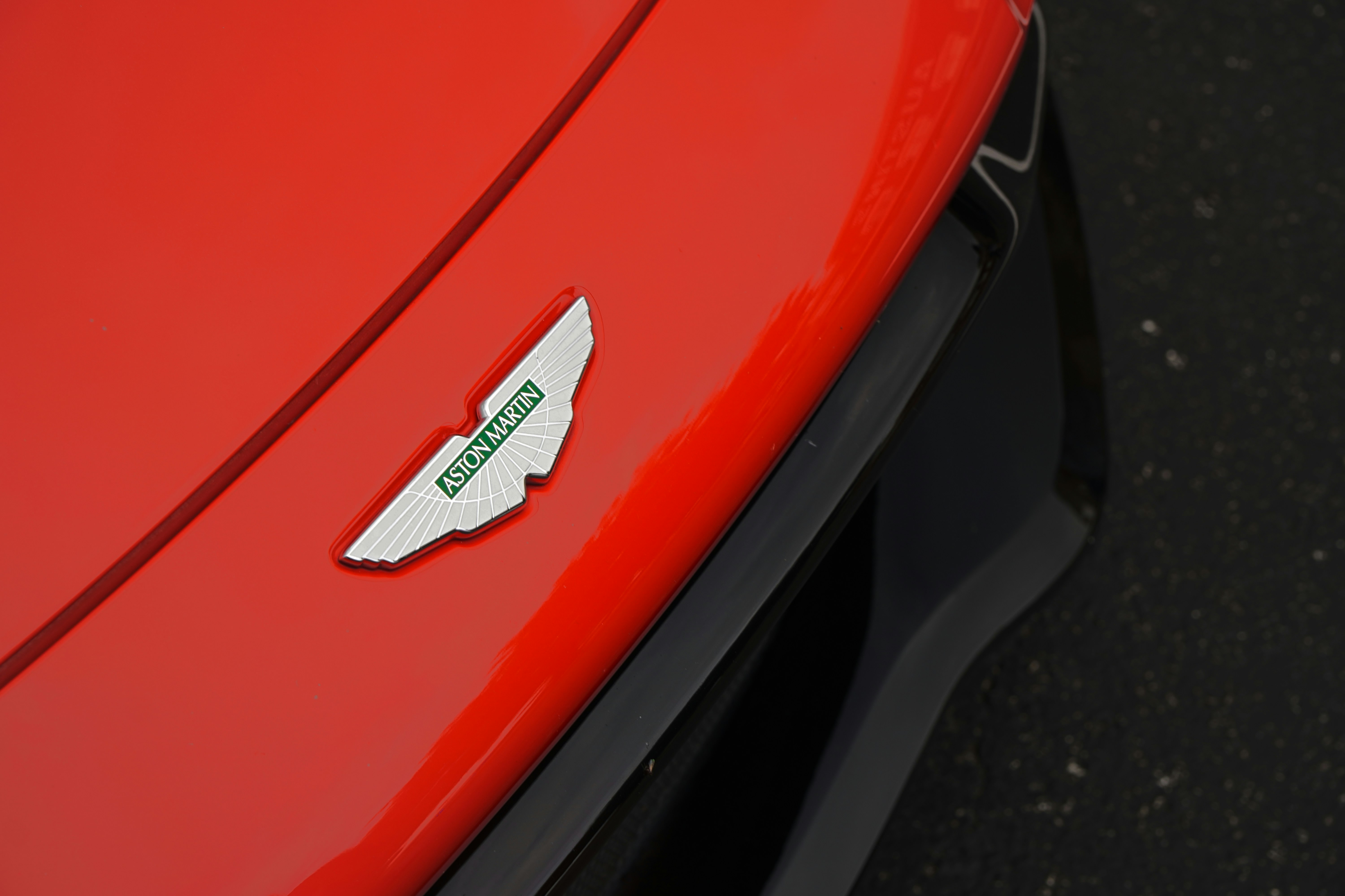 Aston Martin Badge on a Fiery Red Hood