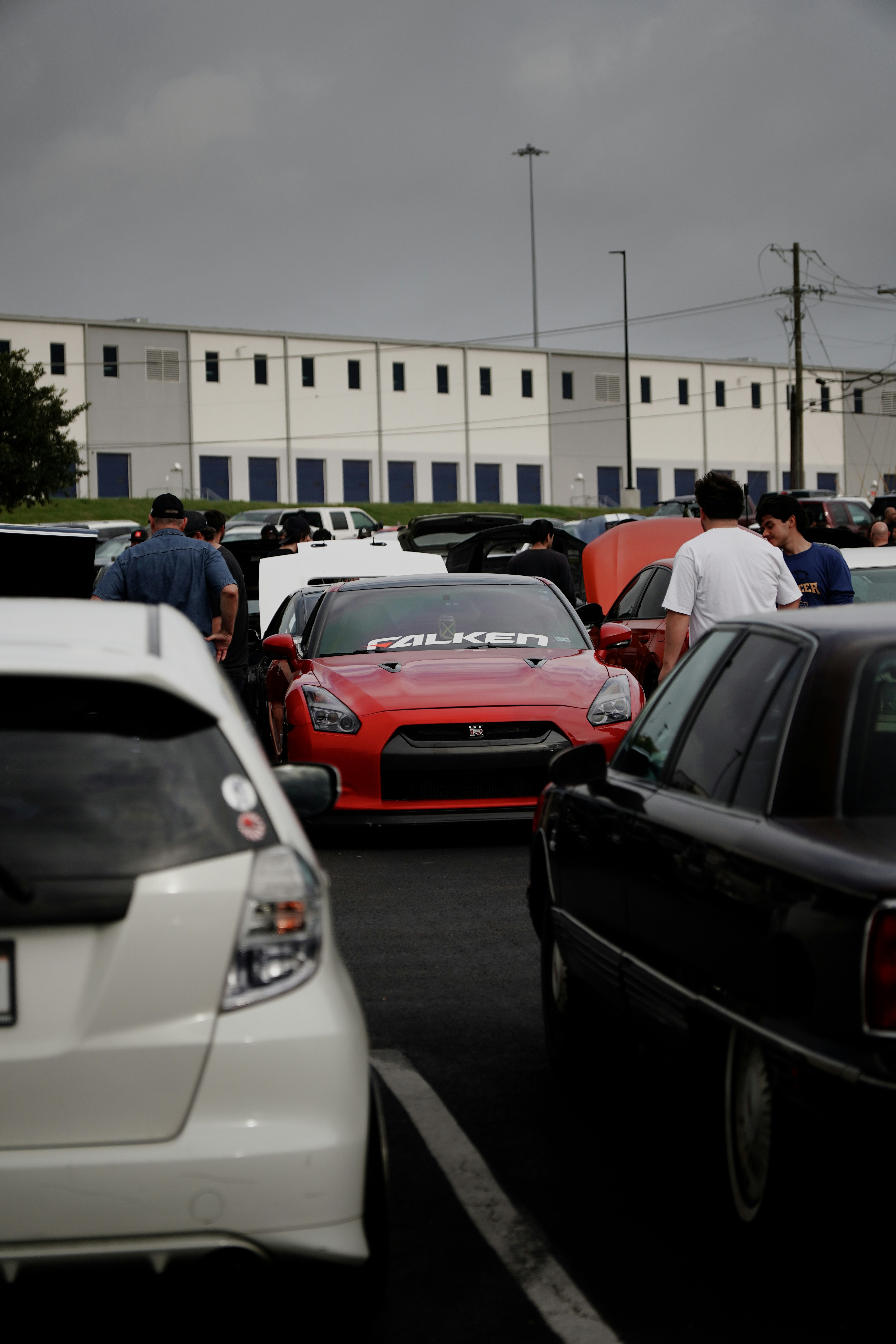 Red Accent, Quiet Battle: A Car Meet Frontal at Dusk