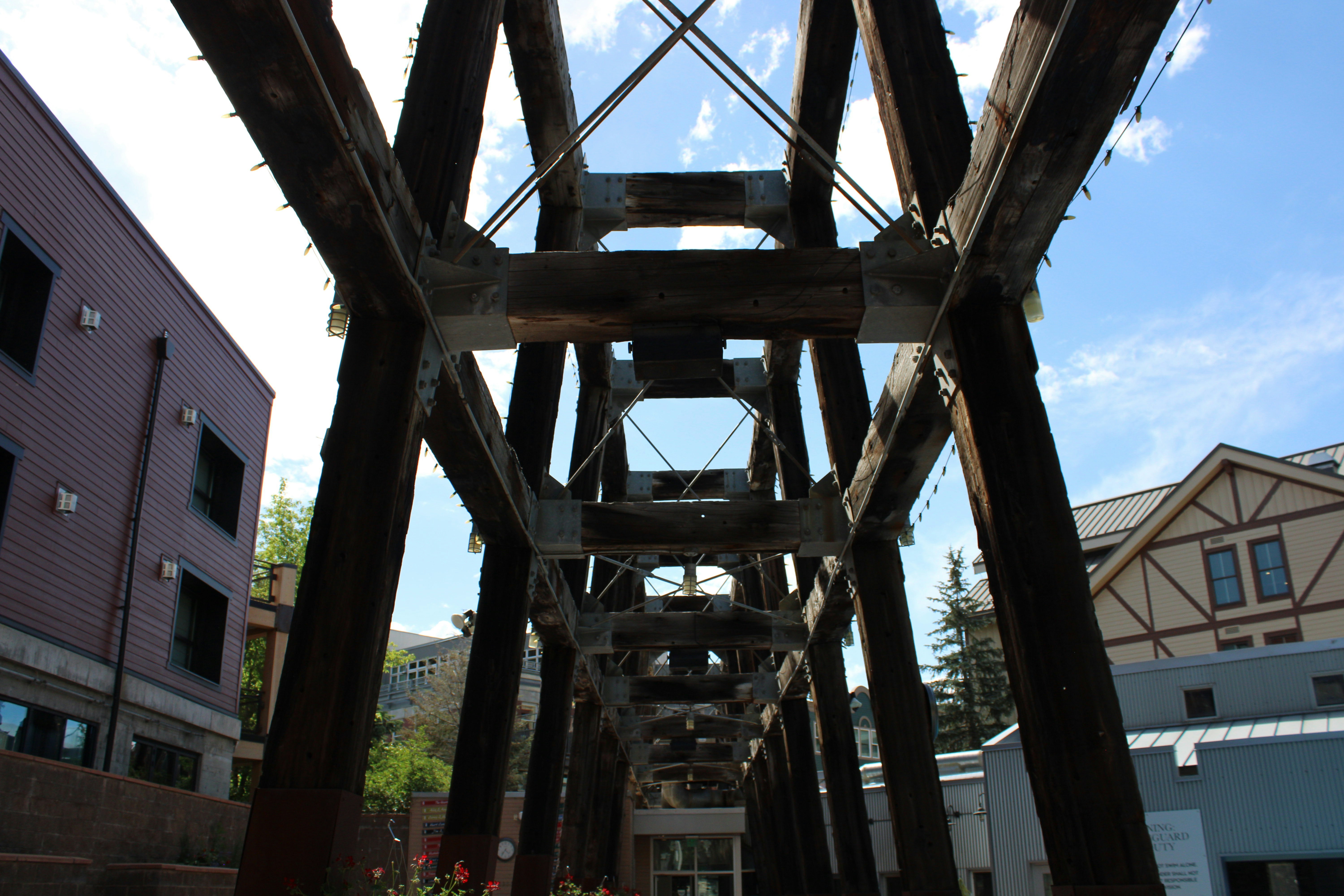 Tunnel of Timber Beams: A Recurring Perspective Under a Weathered Archway