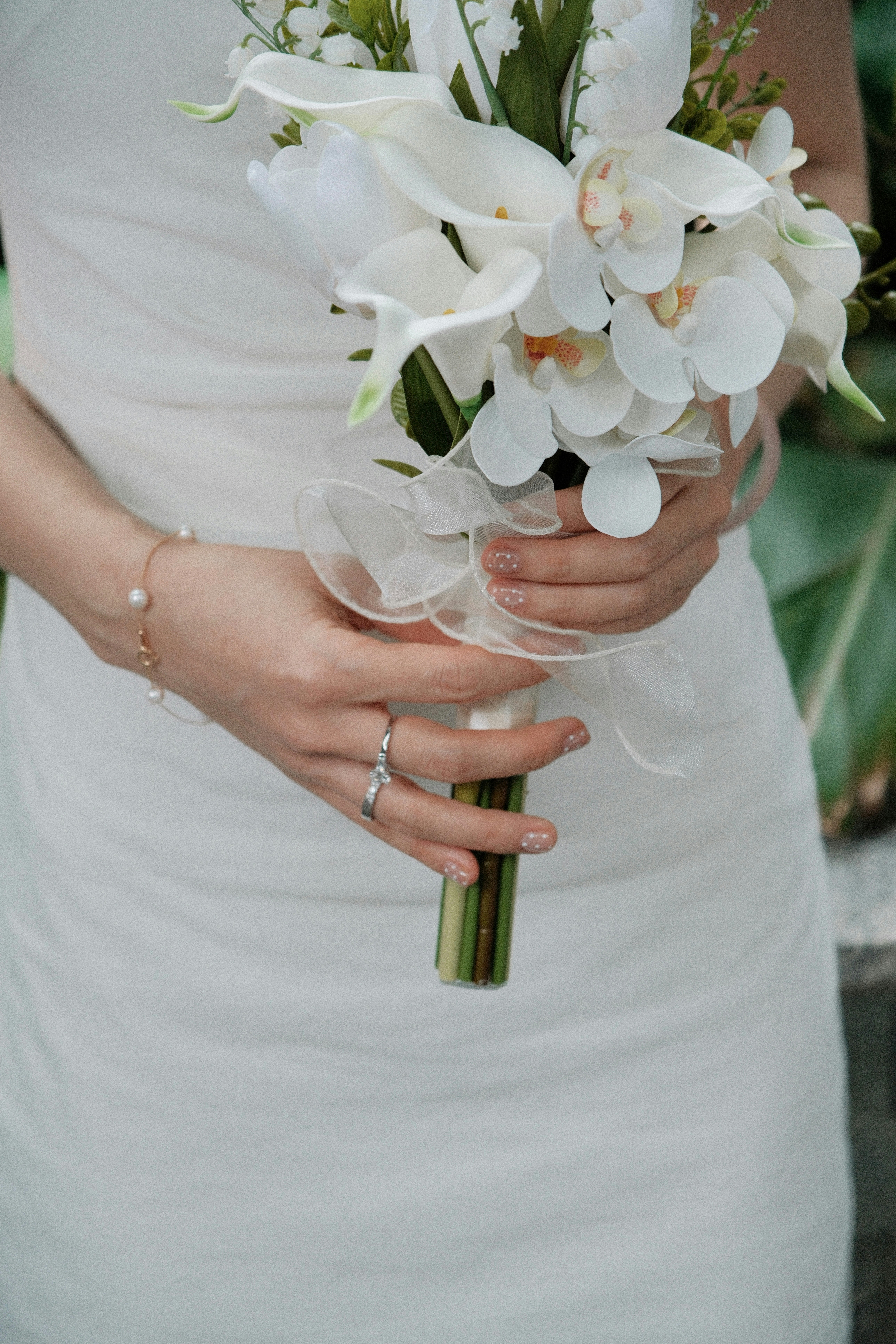 Close-Cut Bouquet Portrait: Bridal Hands Cradling Orchids