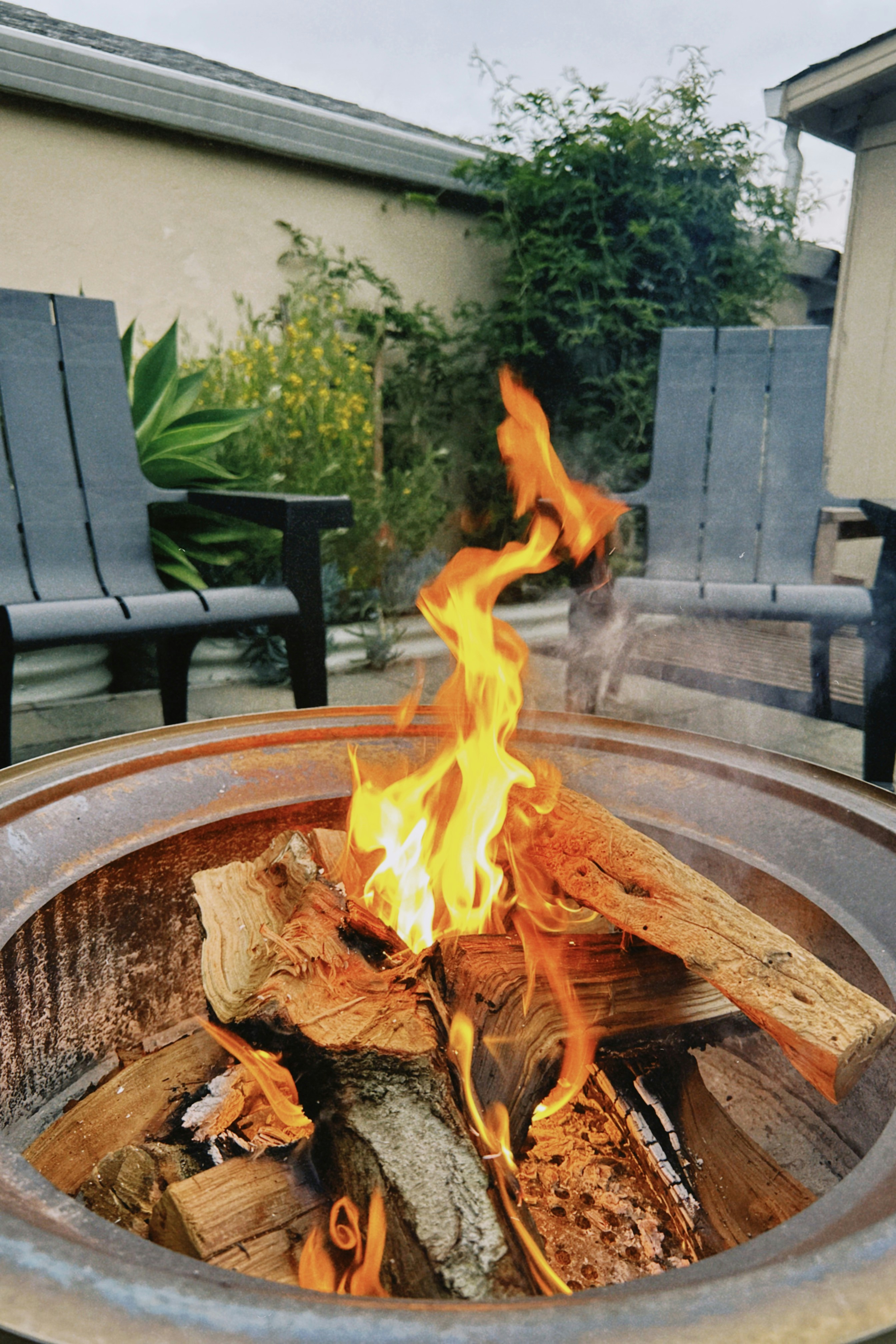 Flames on the Hearth: Firewood in a Backyard Round Fire Pit