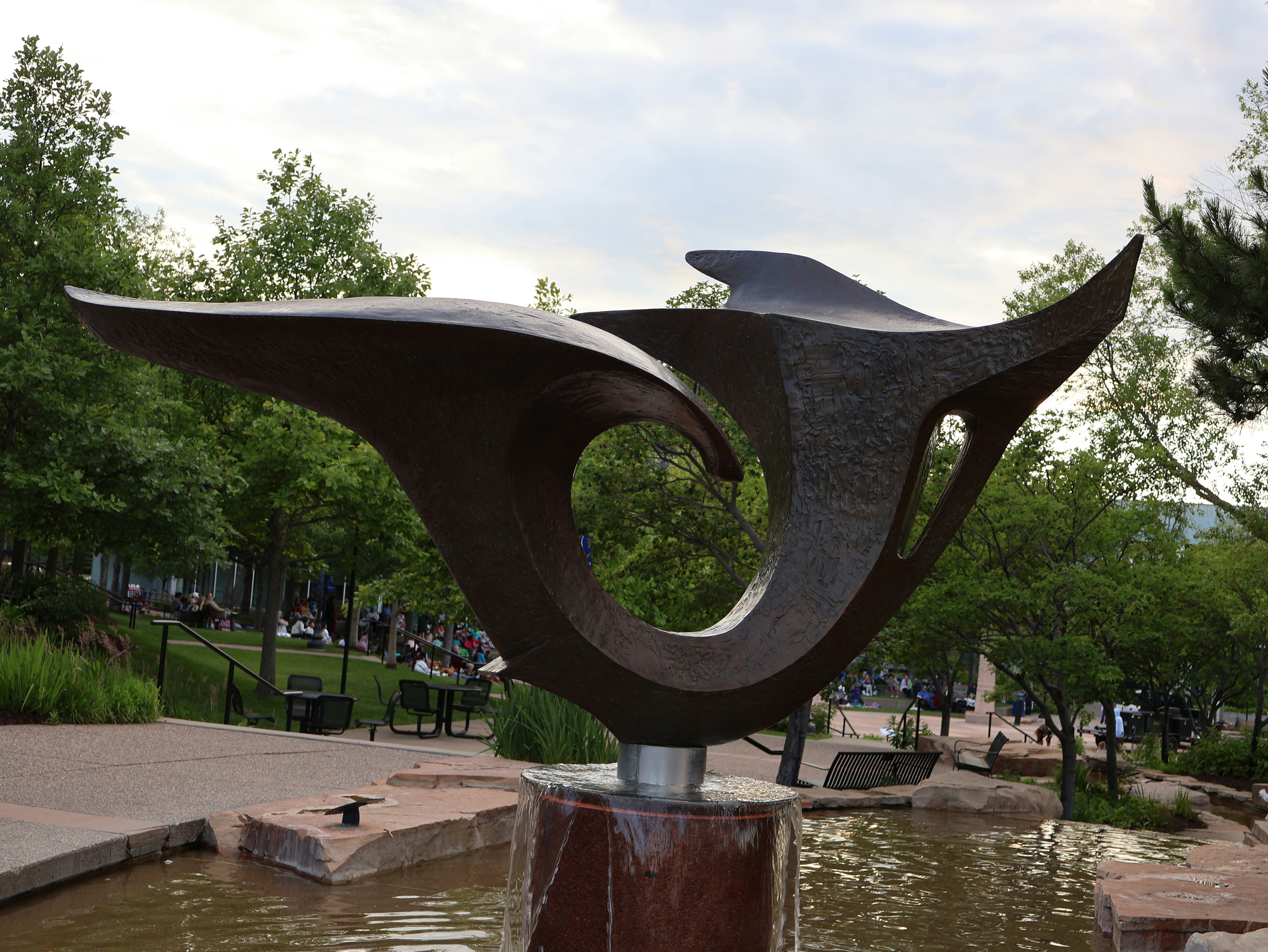 Winged Vessel: A Metal Sculpture Centered in a Park haven