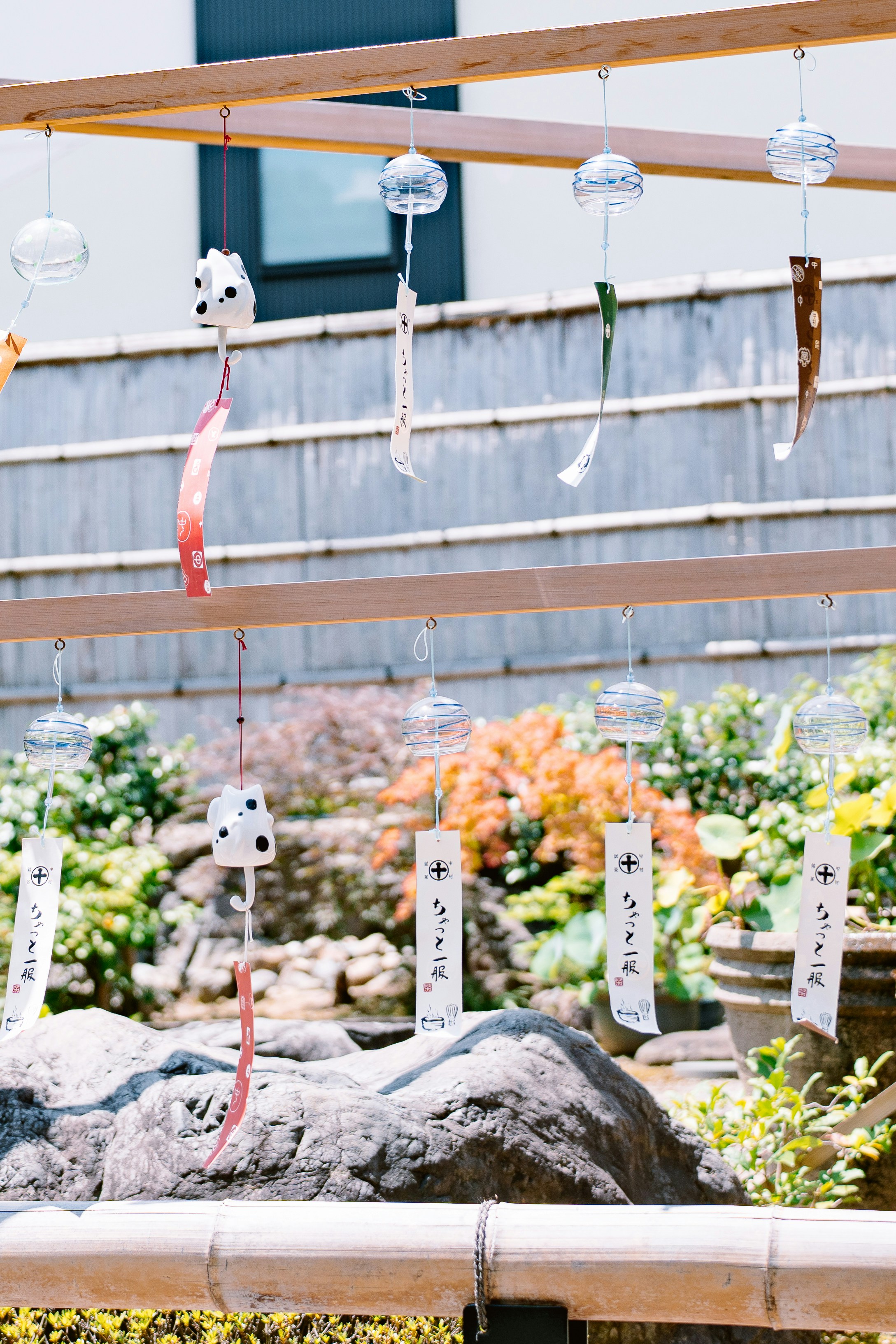 Colorful Weather Vines: Tied Charms Swinging Across a Japanese Garden