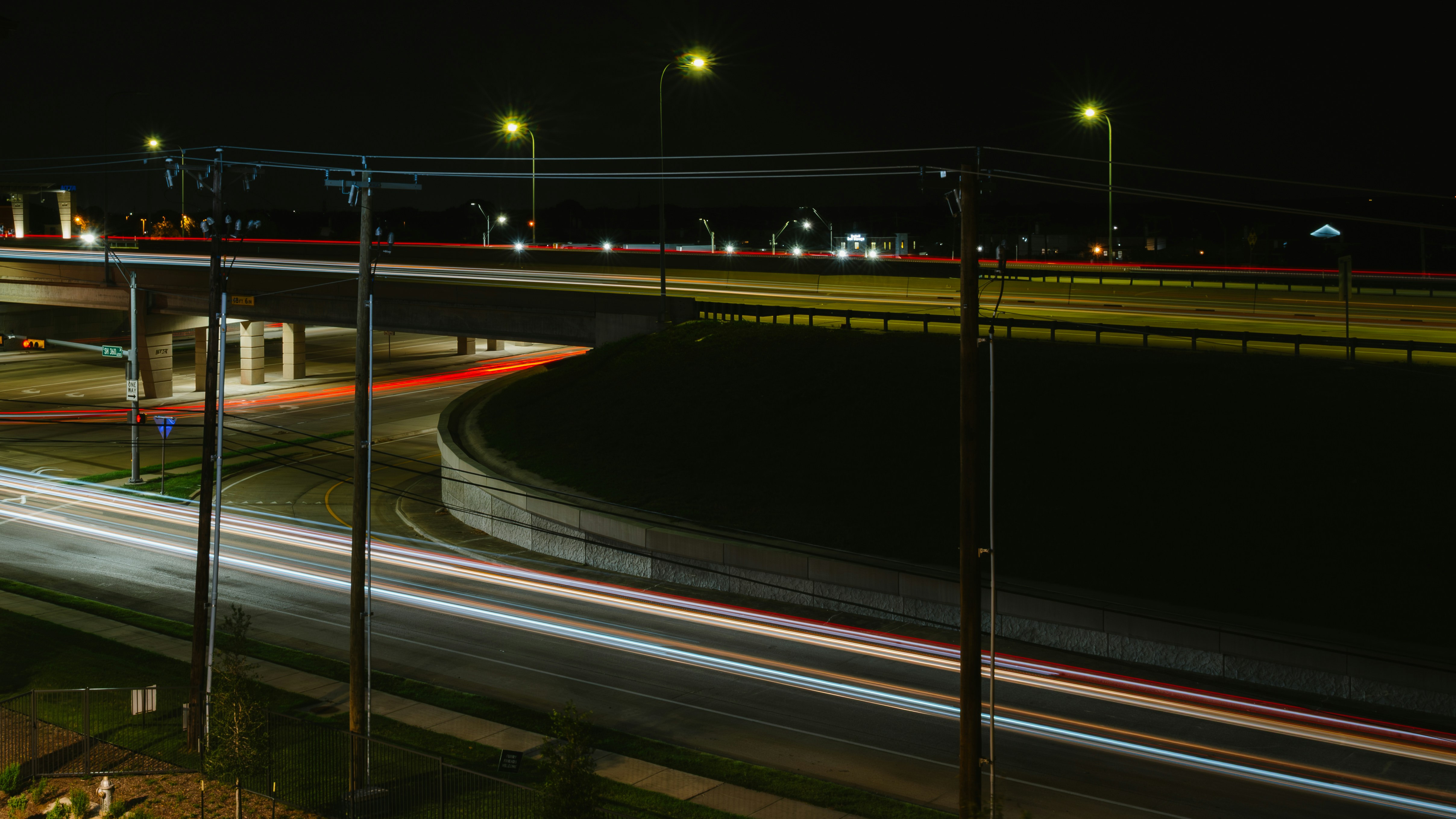Night Highway Blur: Light Trails and an Overpass Symphony