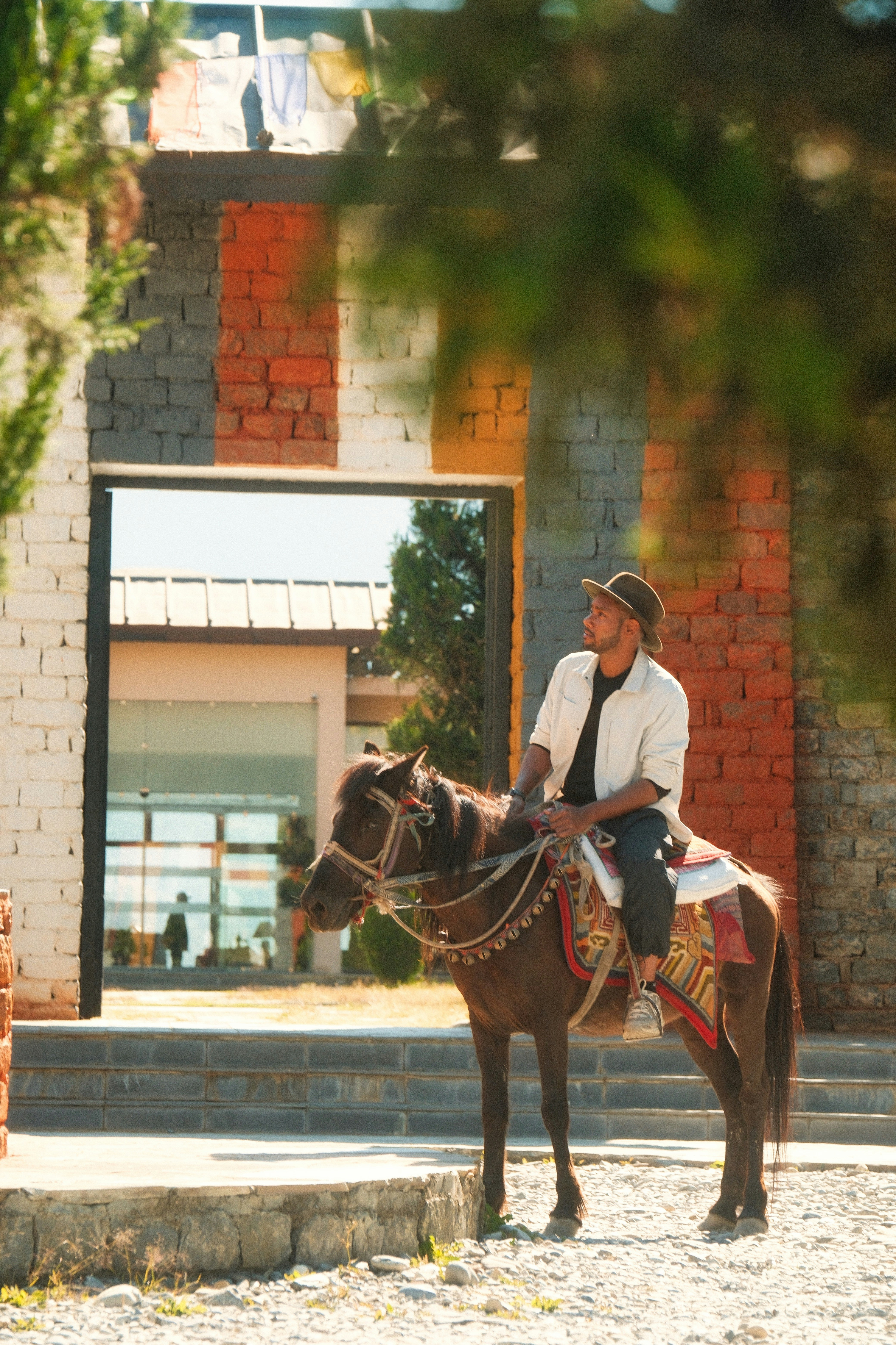 Rider at the Gate: A Quiet Moment by Colorful Brickwork