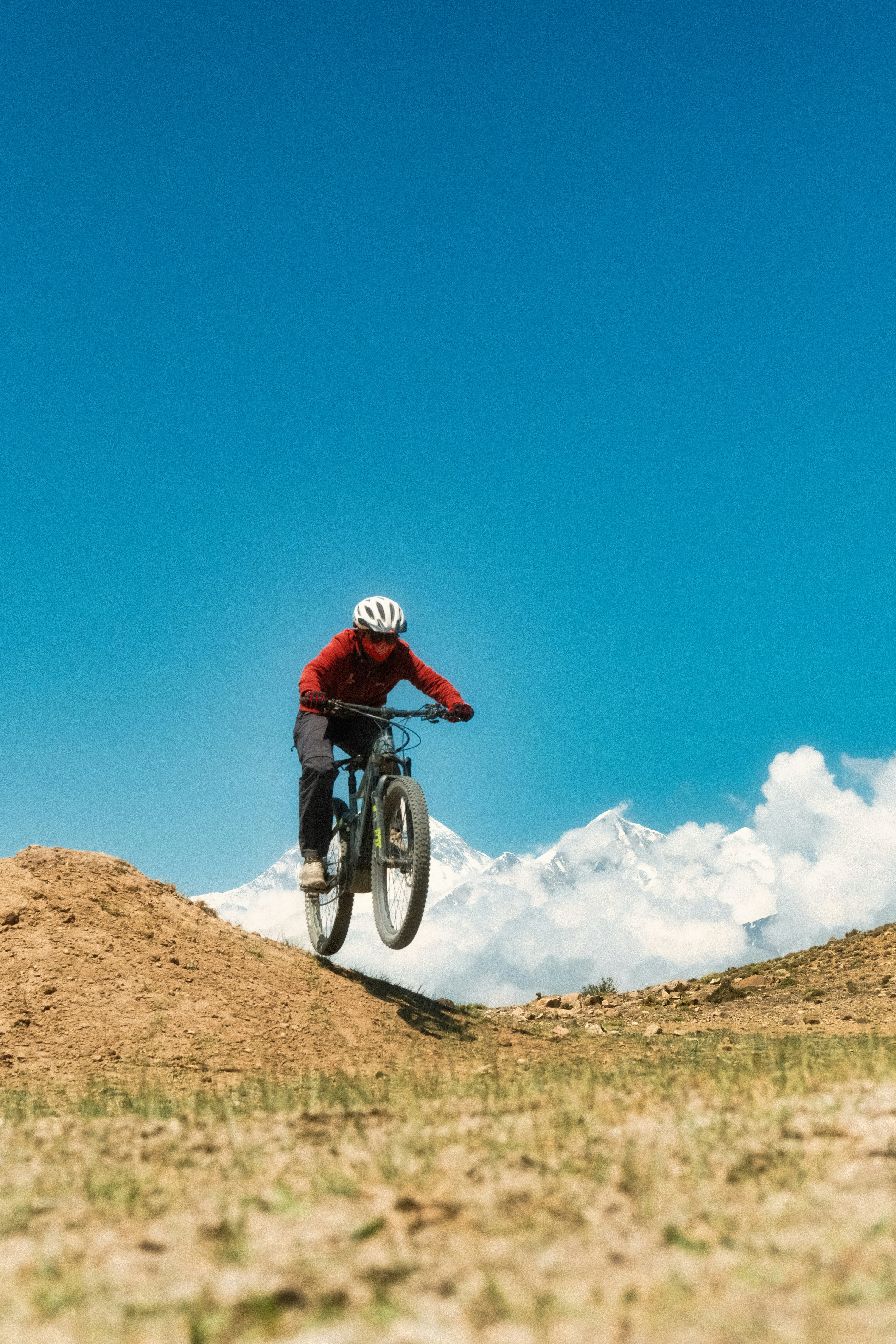 Midair Mountain Ride: Rider Conquers a Dusty Descent