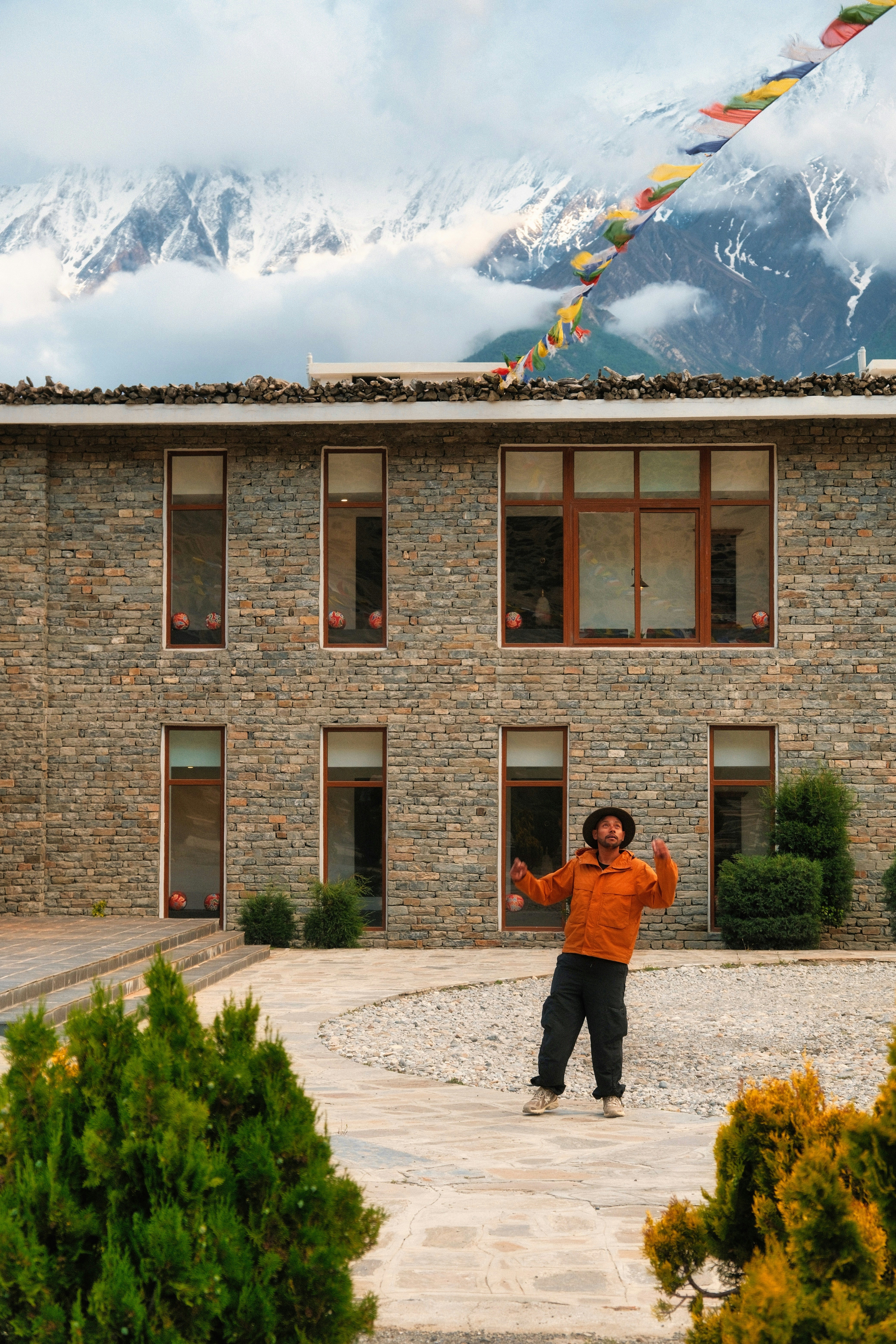 Traveler in Orange: A Portrait Before the Mountain House