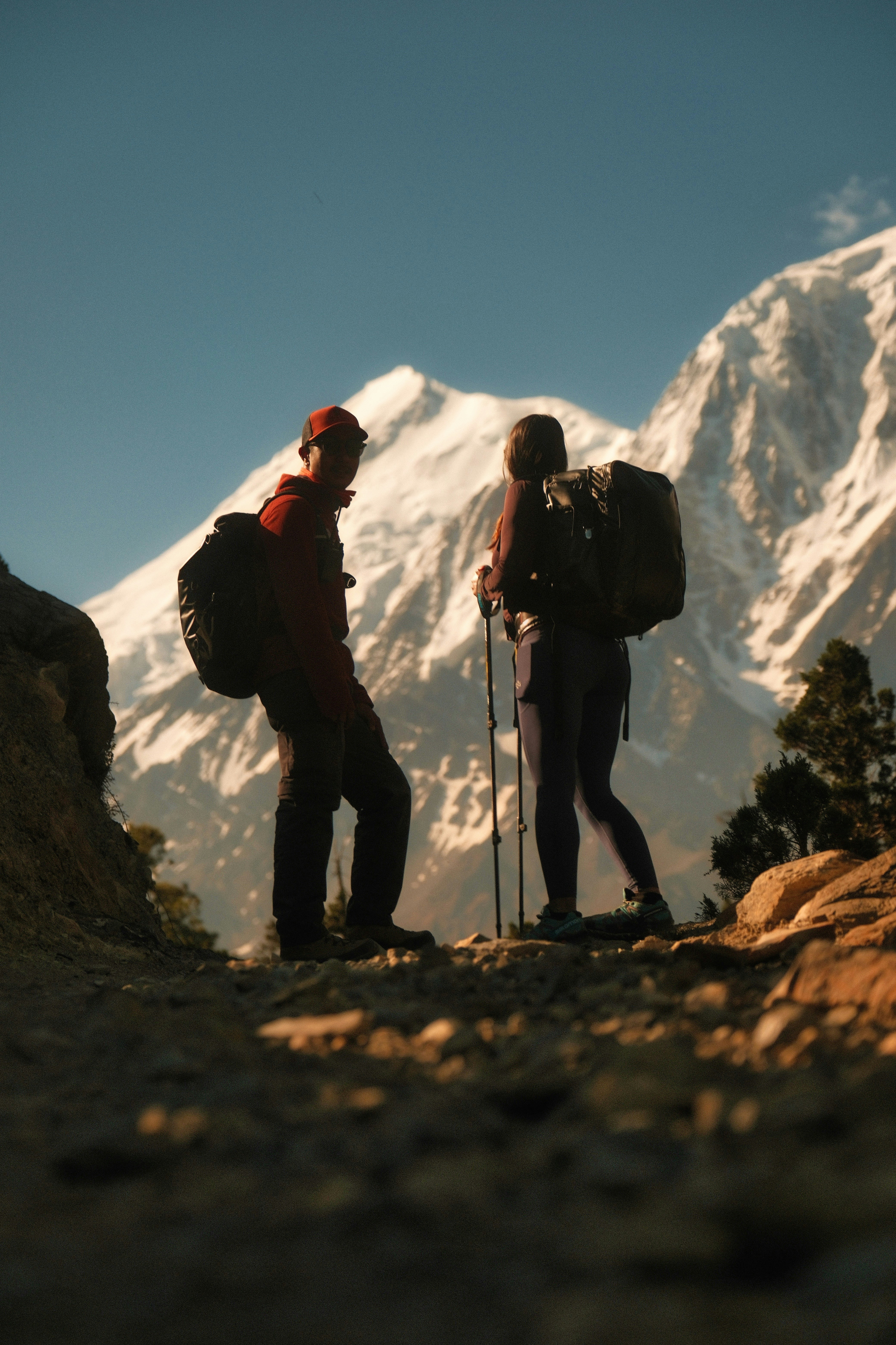 Climbers in Shadowed Ambition as Alpine Peaks Loom
