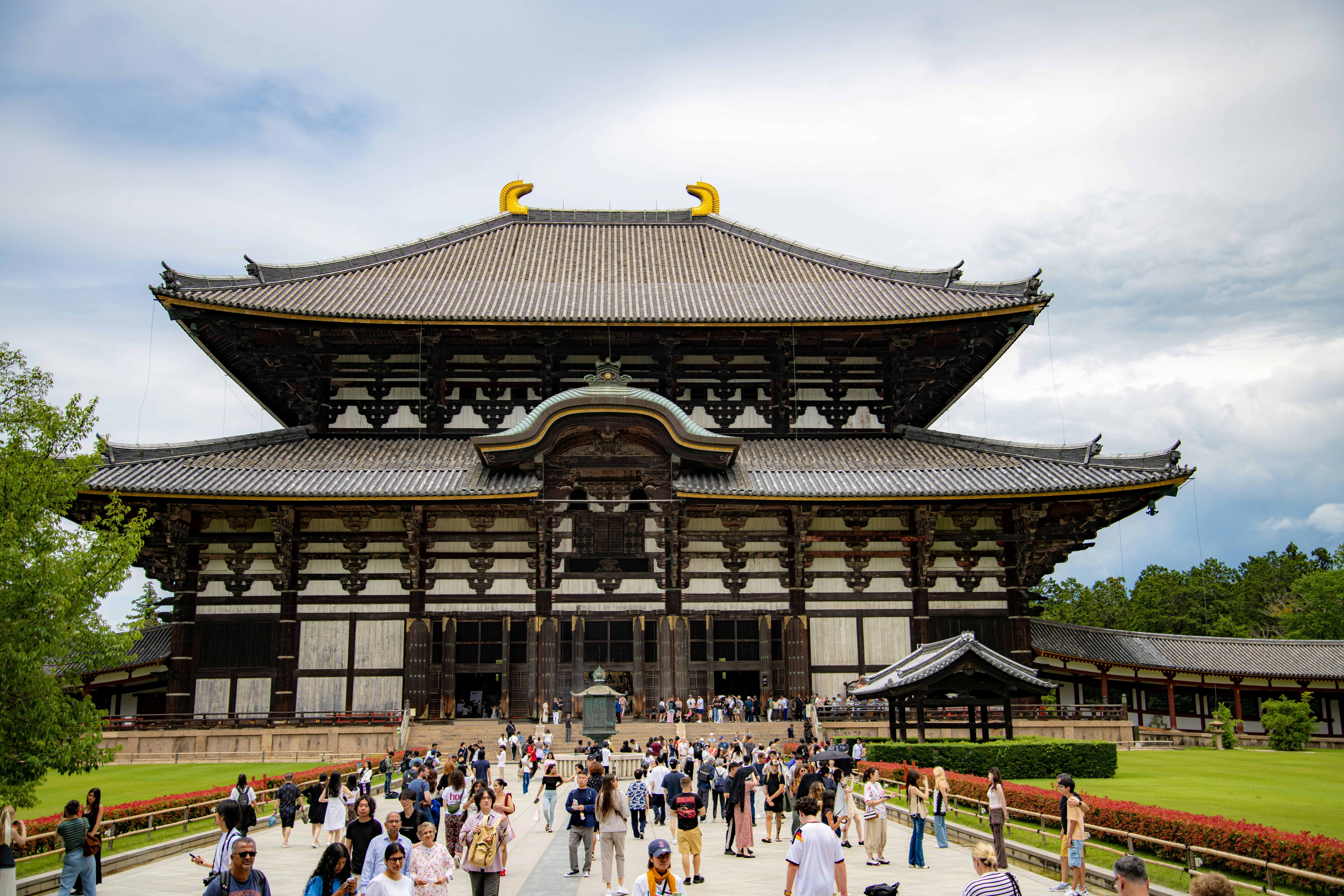 Temple Steps: Visitors Converge Before a Grand Traditional Hall