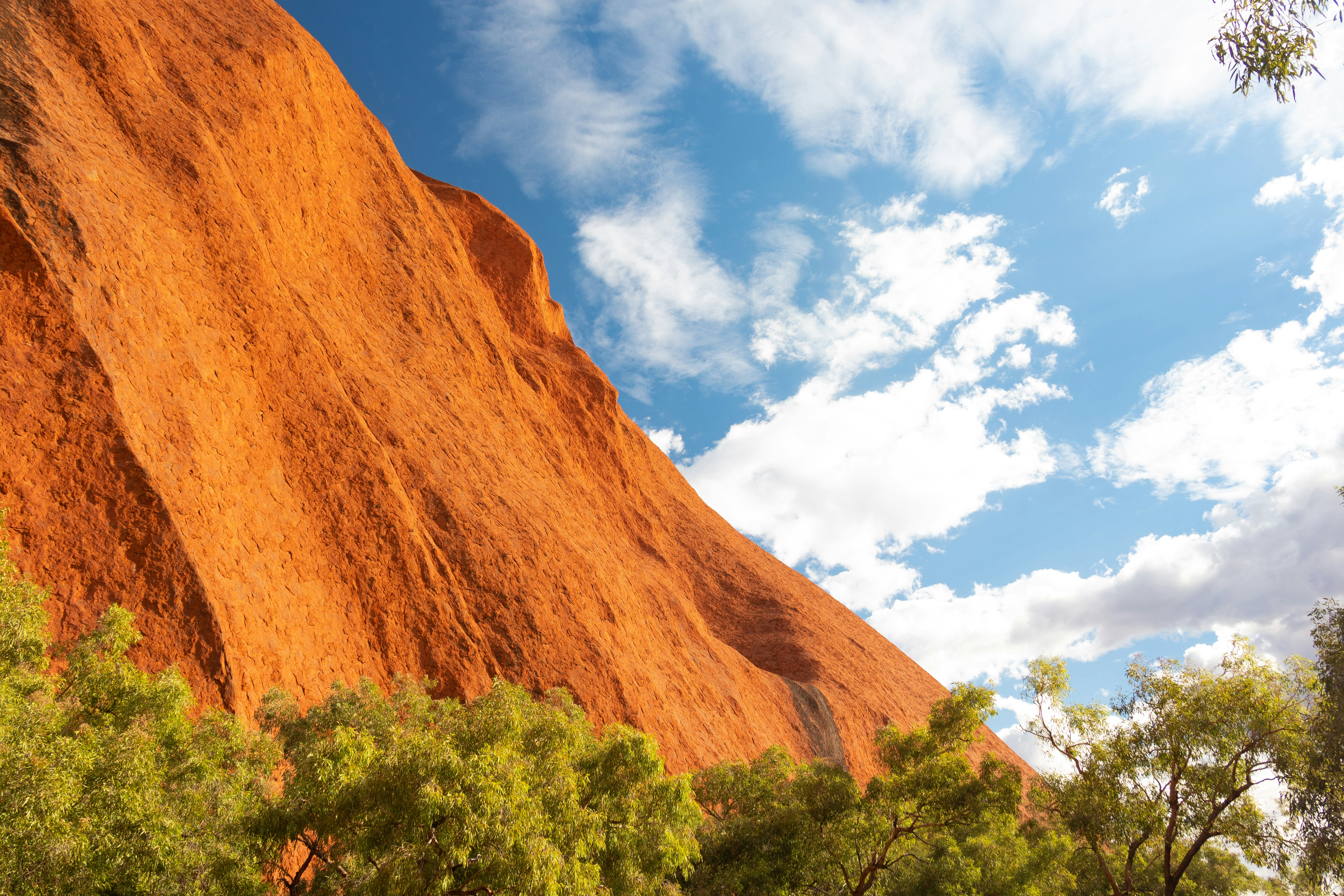 Sunlit Uluru-like Cliff Crowned by Sky